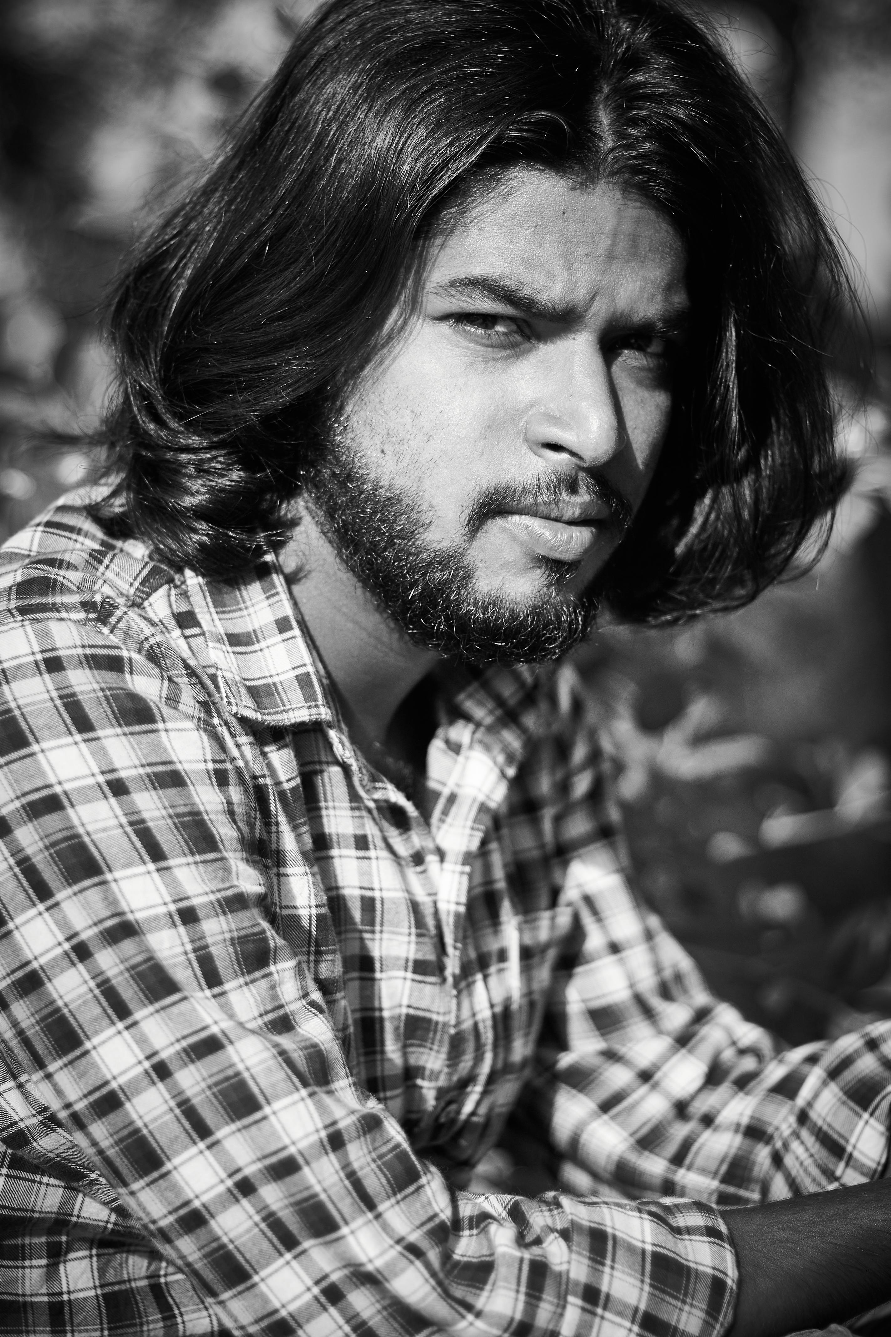 A Man Sitting on Plastic Chair · Free Stock Photo