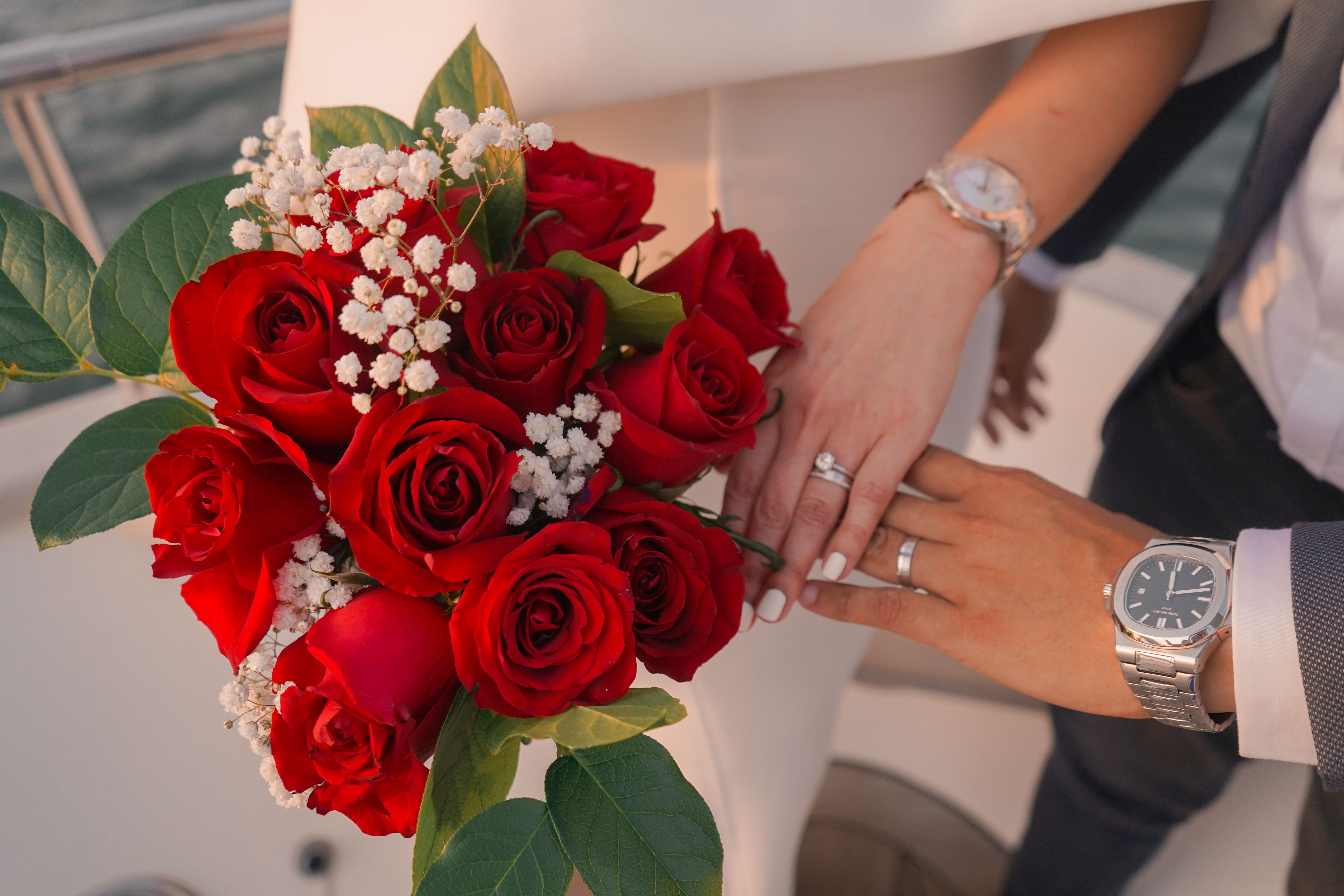 Hands of Bride and Groom by Red Roses Bouquet · Free Stock Photo