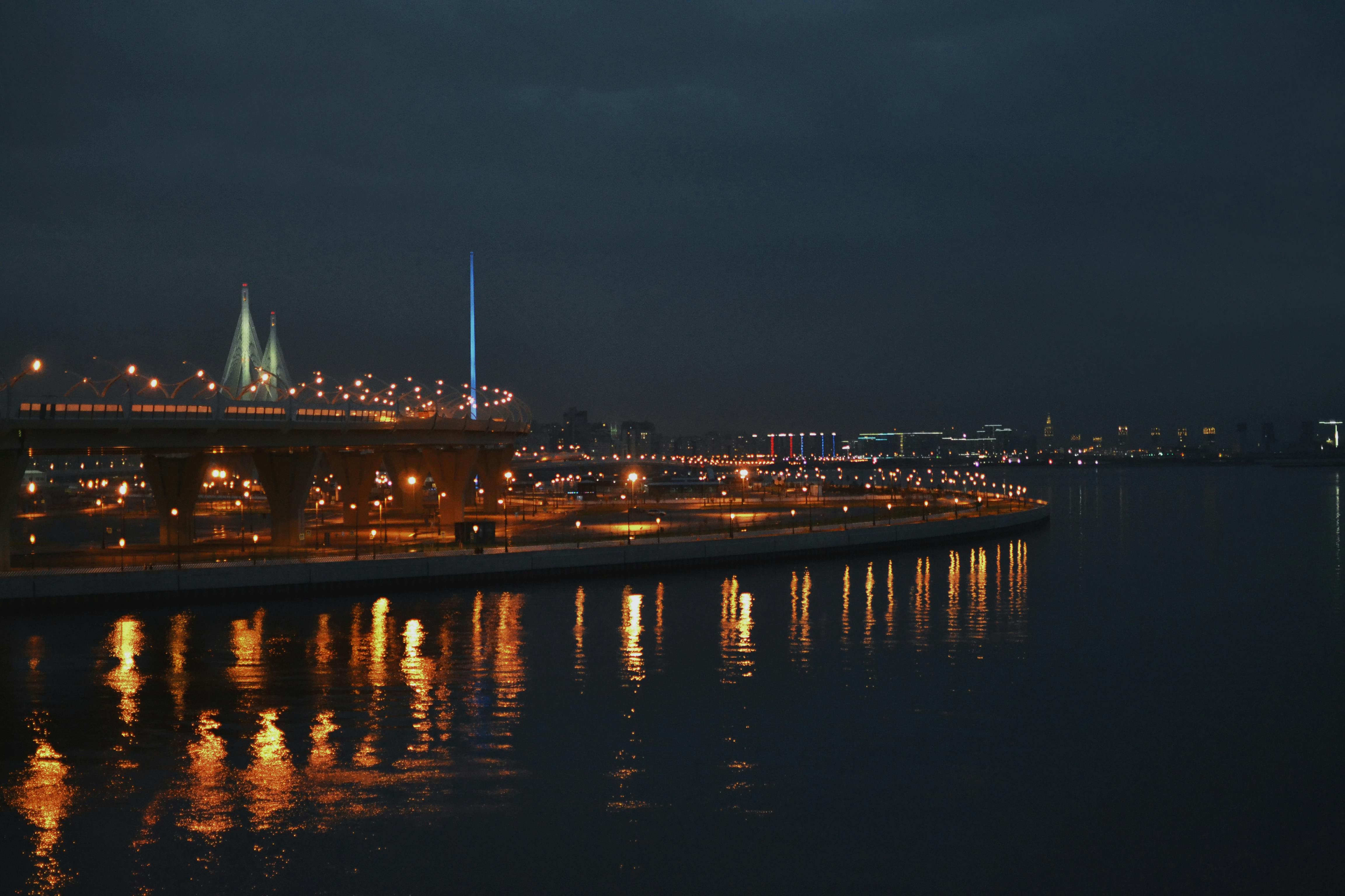 Street Lights Reflections on Body of Water during Night Time · Free ...