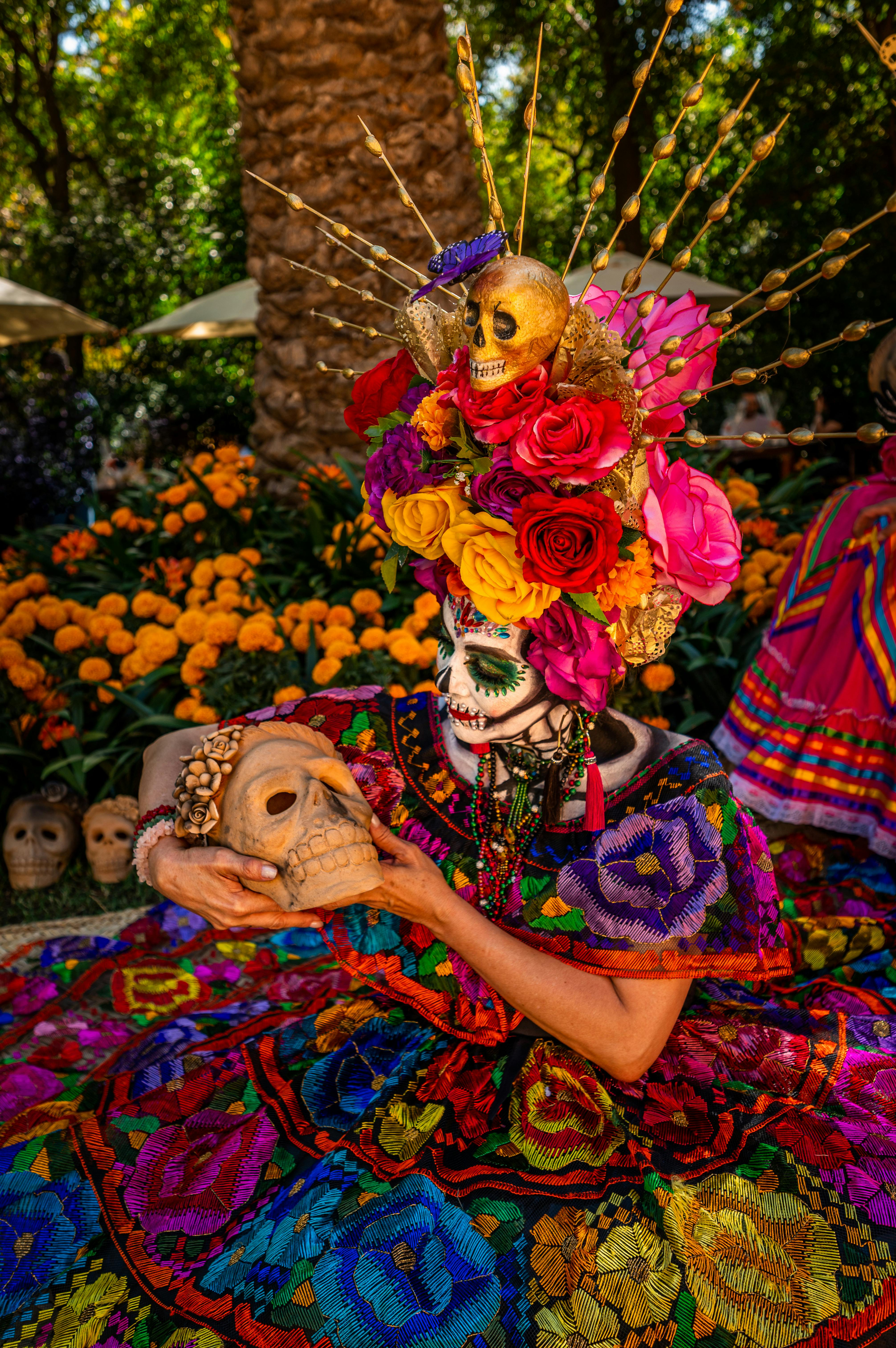 Catrina with a Skull in Her Hands Sitting in the Garden · Free Stock Photo