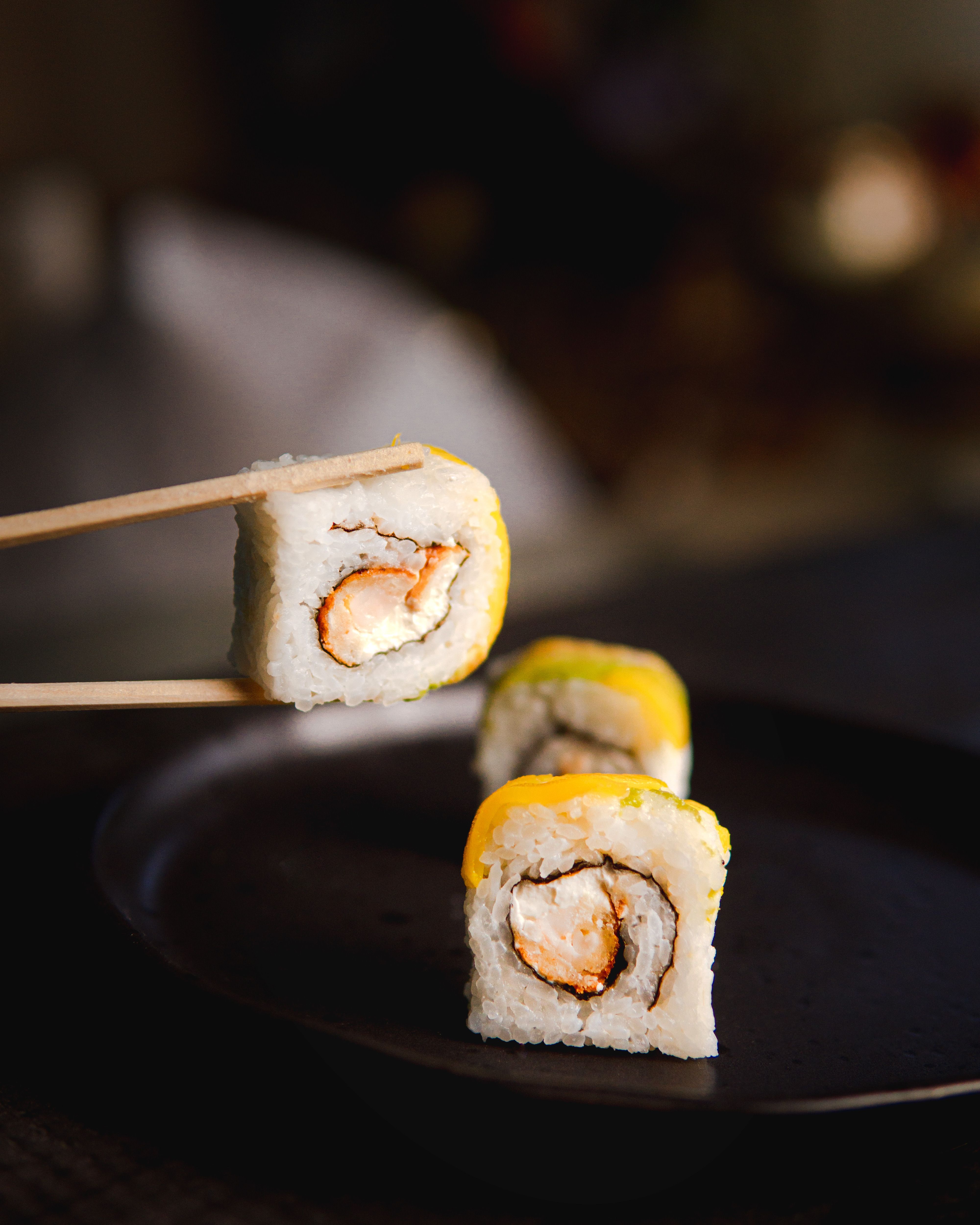Close-Up of a Person Eating Sushi · Free Stock Photo