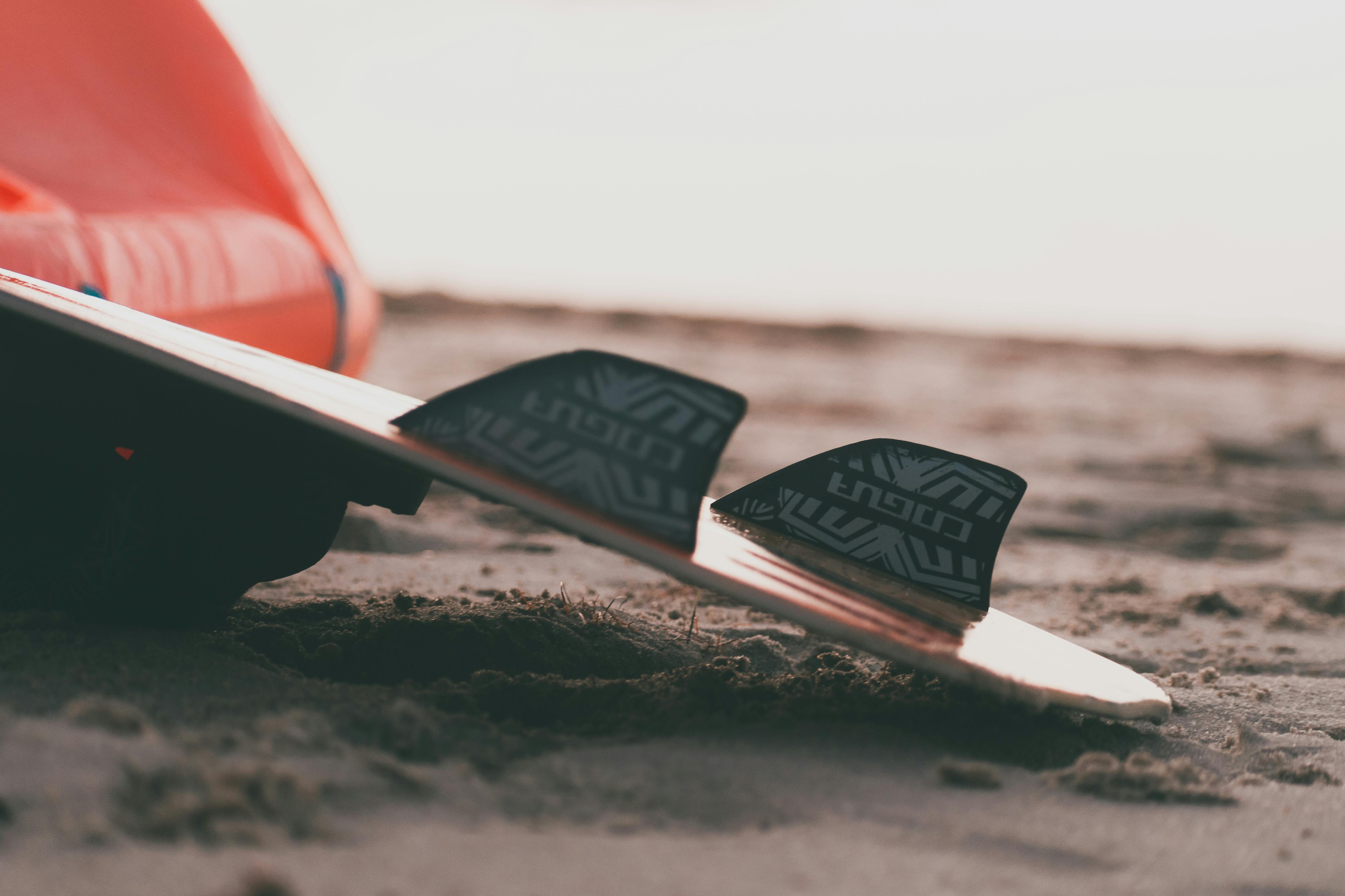 High-Angle Shot of a Surfboard on the Shore · Free Stock Photo