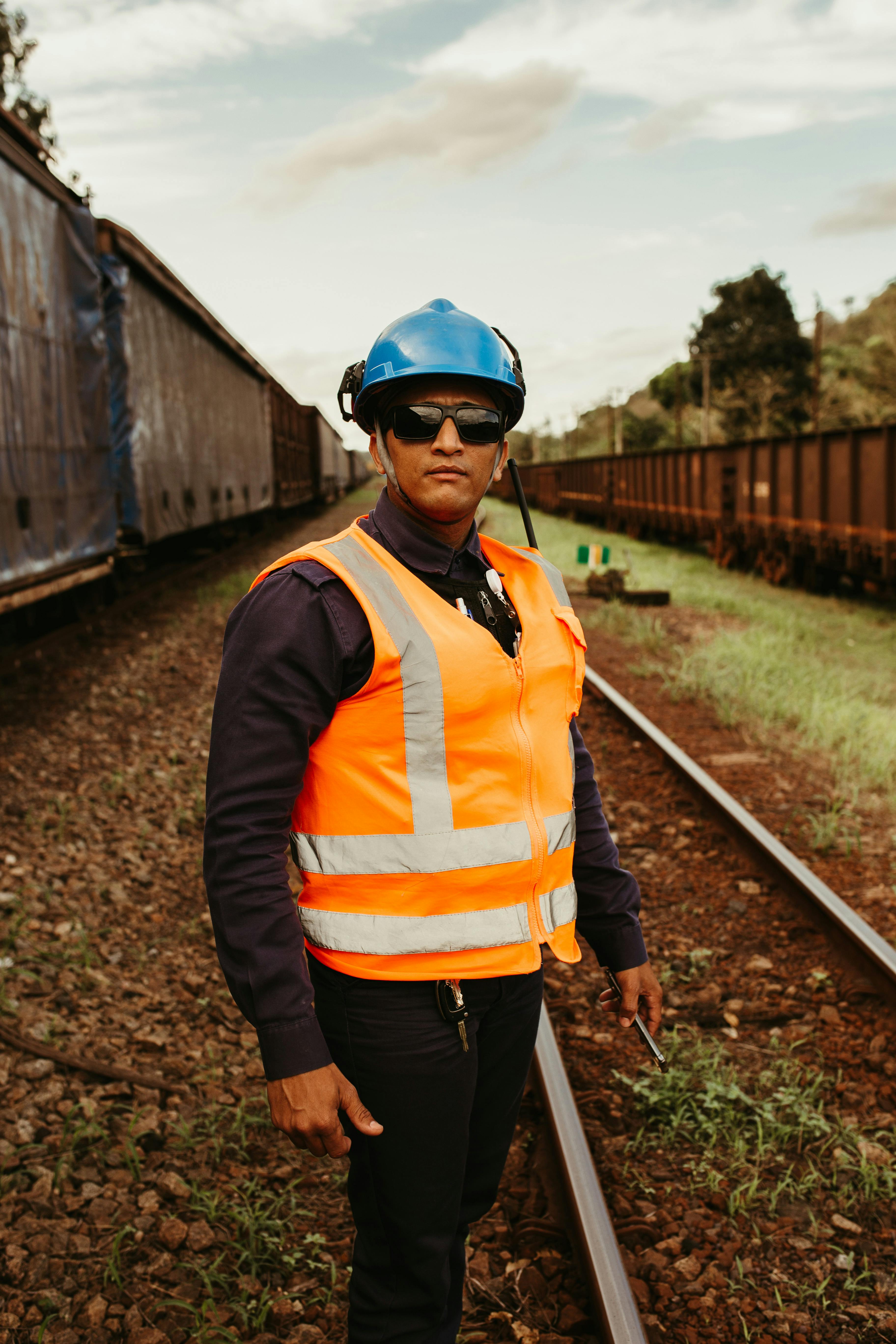 A Worker Wearing a Safety Helmet and Safety Vest while Standing on a ...