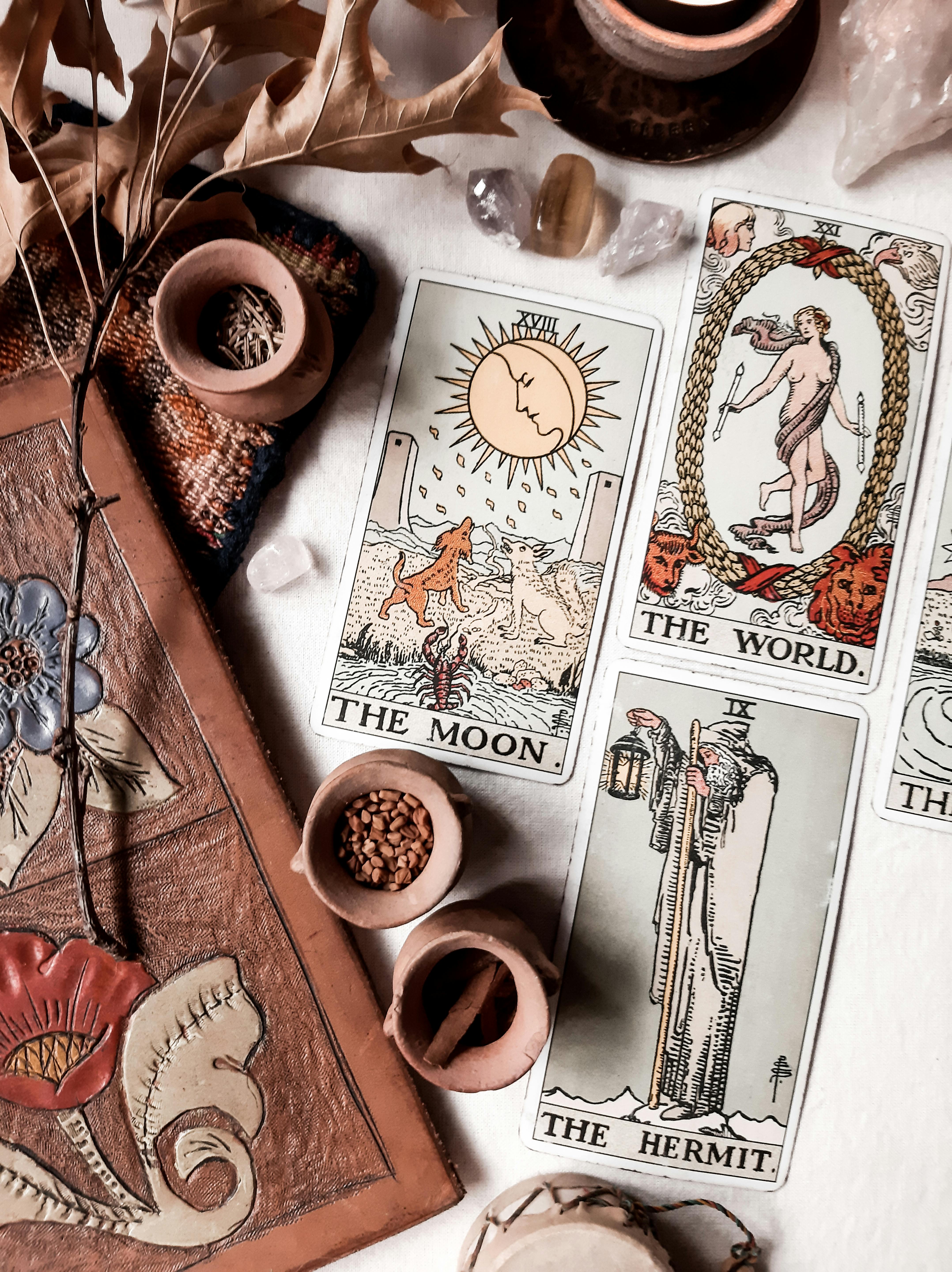 Tarot Cards and Clay Jars on a White Surface · Free Stock Photo