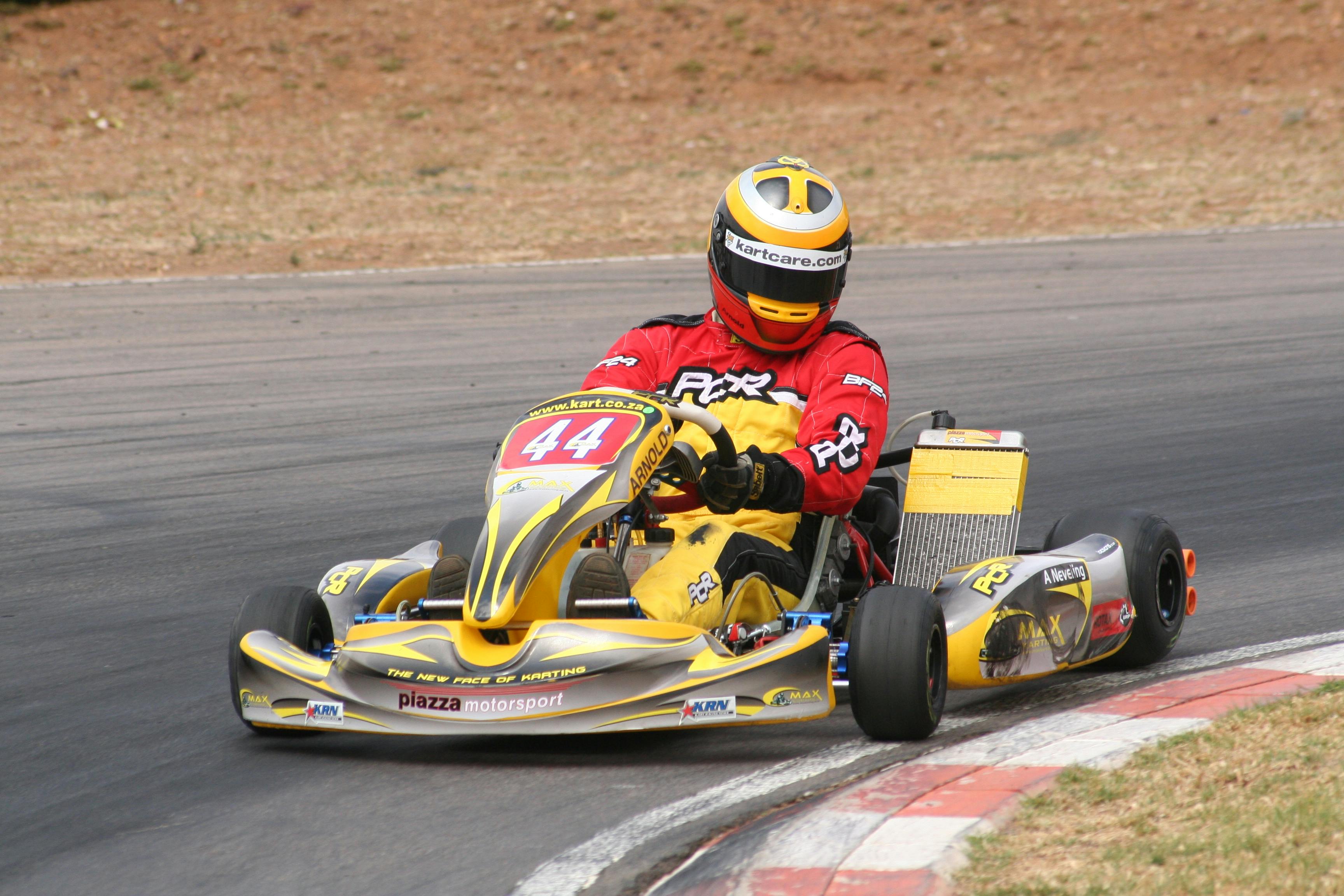 Man Driving a Yellow Go Kart · Free Stock Photo