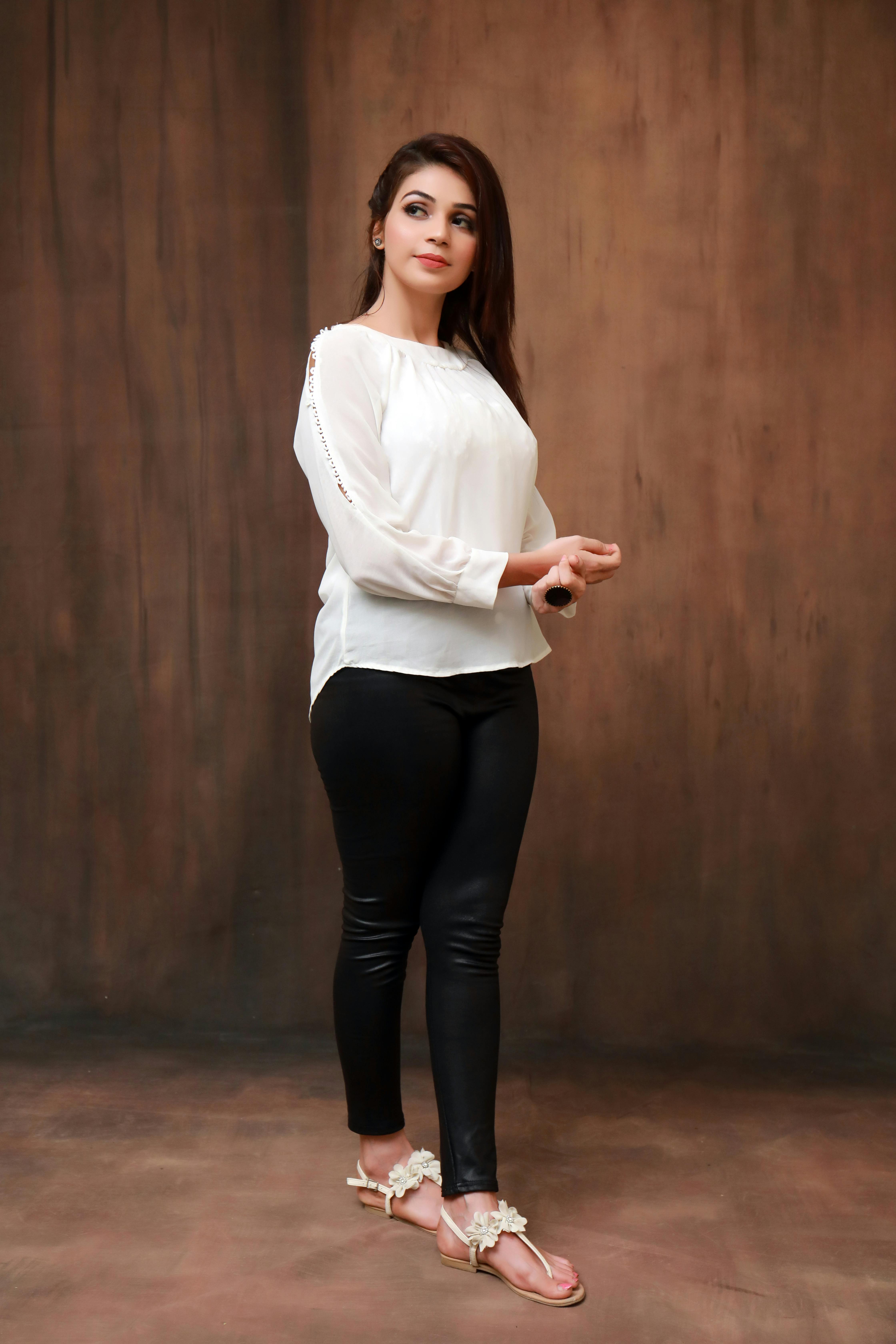 Beautiful Woman Wearing White Top and Black Pants · Free Stock Photo