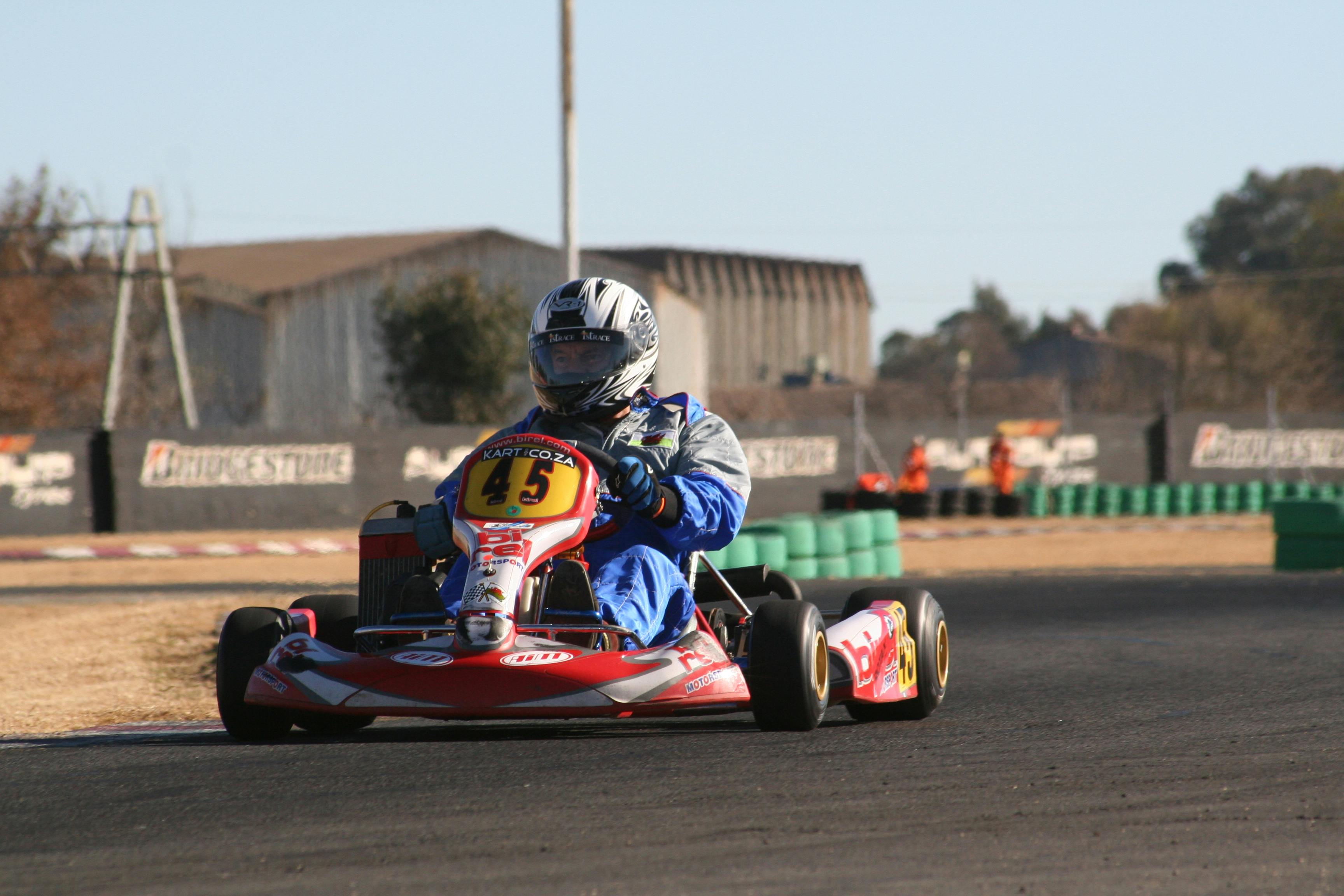 Racer Driving a Red Go Kart · Free Stock Photo