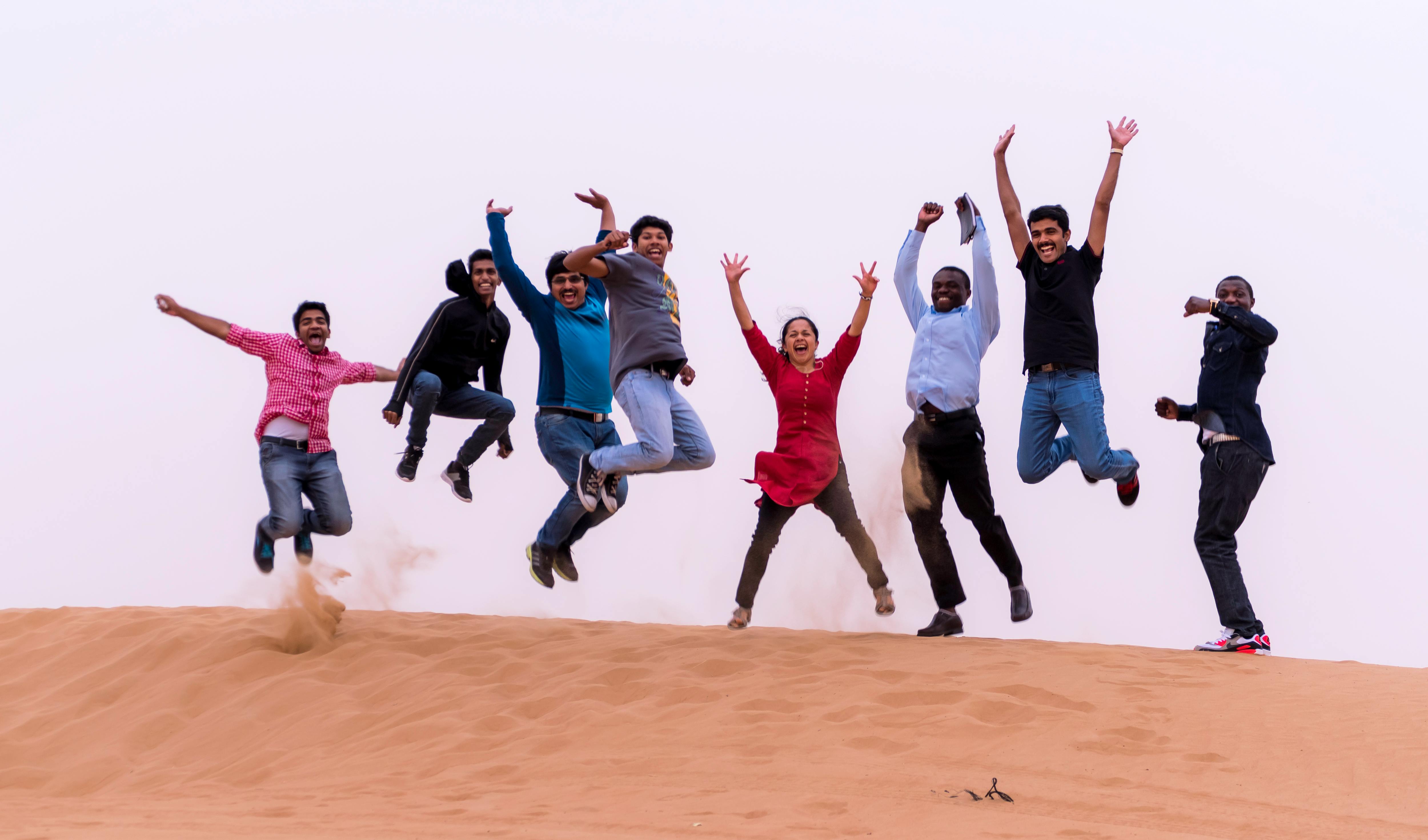 A Jump Shot Photo of a Group of People · Free Stock Photo