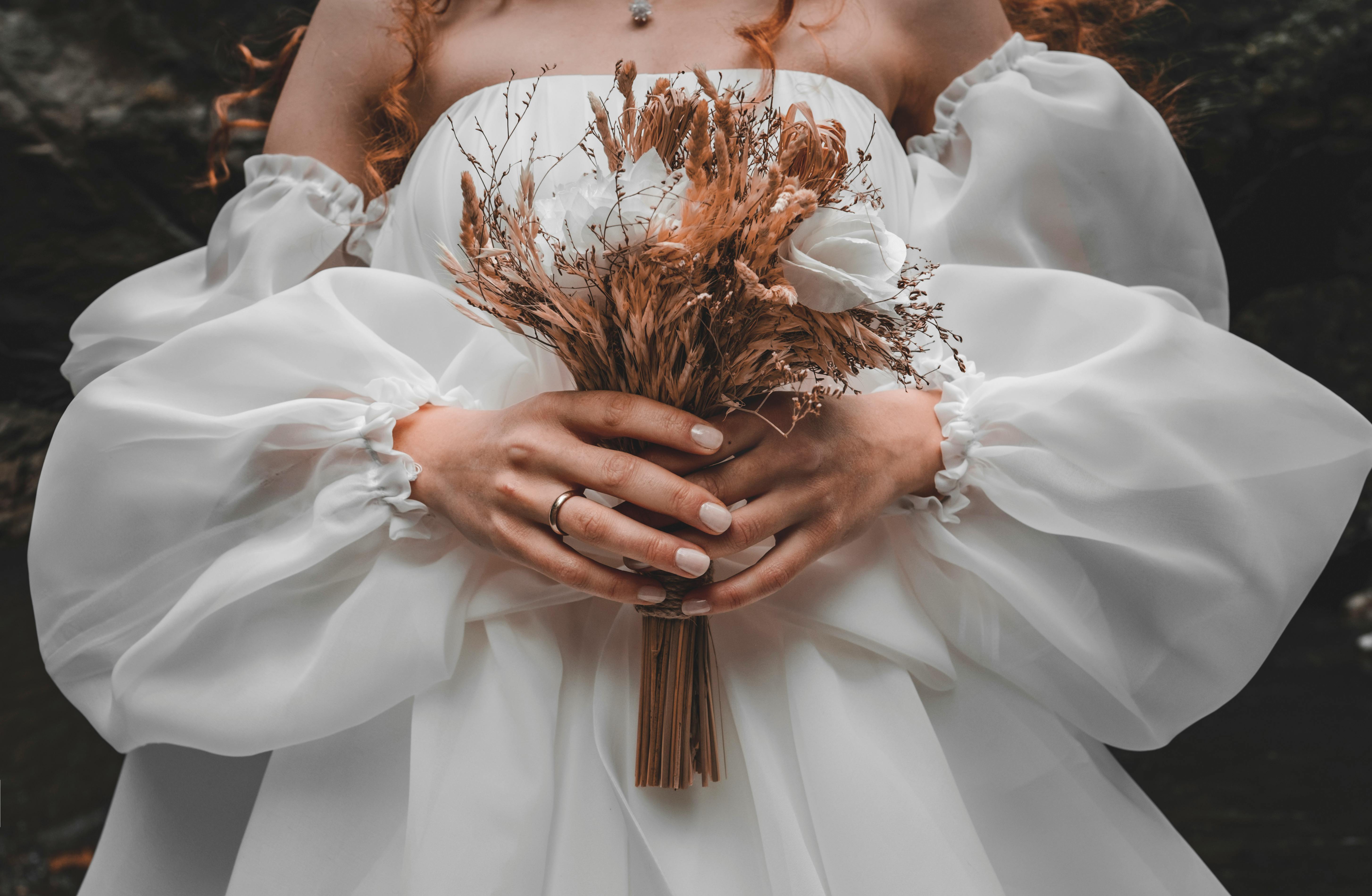 Hand Holding a Bunch of Flowers · Free Stock Photo