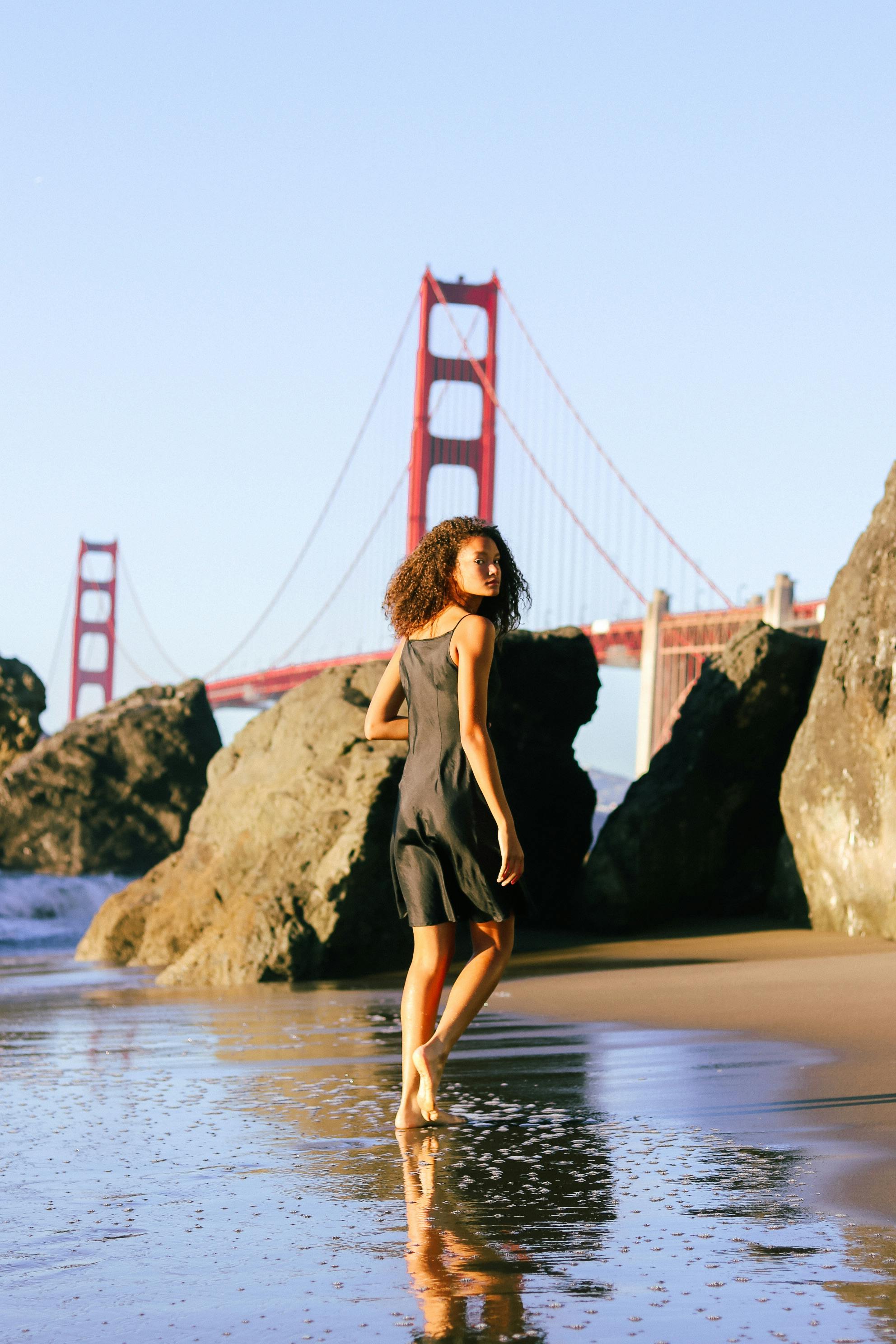 Girl Walking Barefoot on a Shore with Rocks · Free Stock Photo