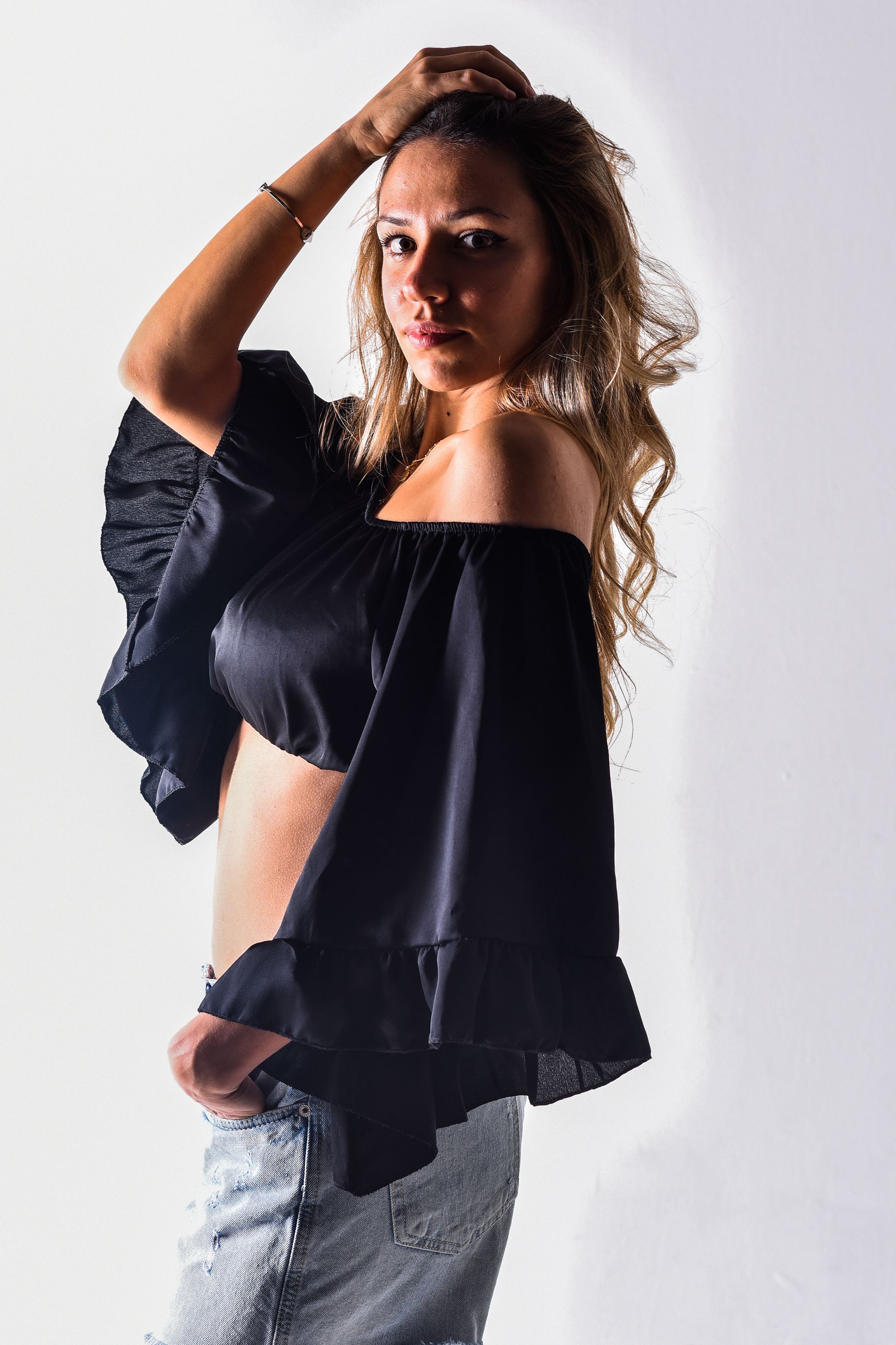Woman in Denim Skirt Posing on Rooftop · Free Stock Photo
