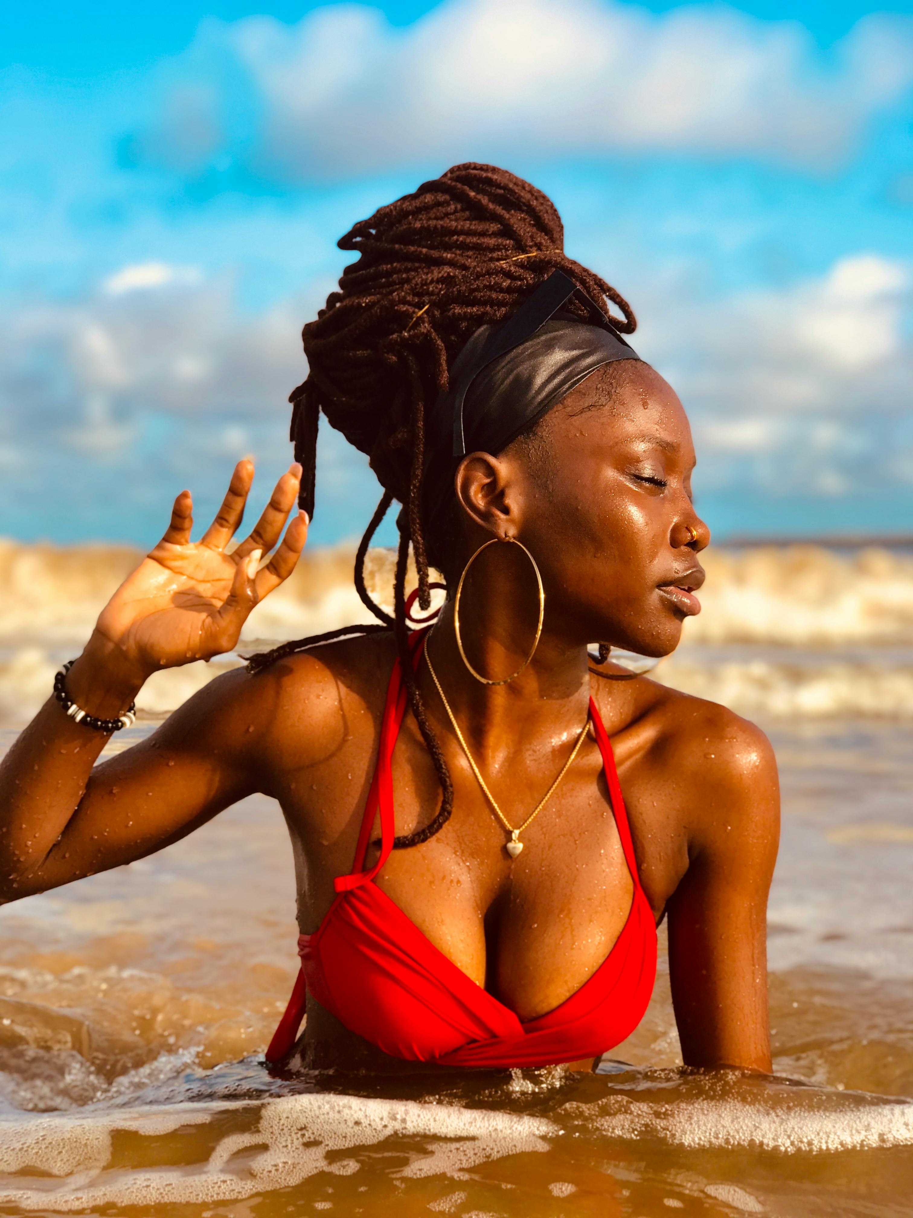 A Woman in Red Bikini Top Soaking in the Water · Free Stock Photo