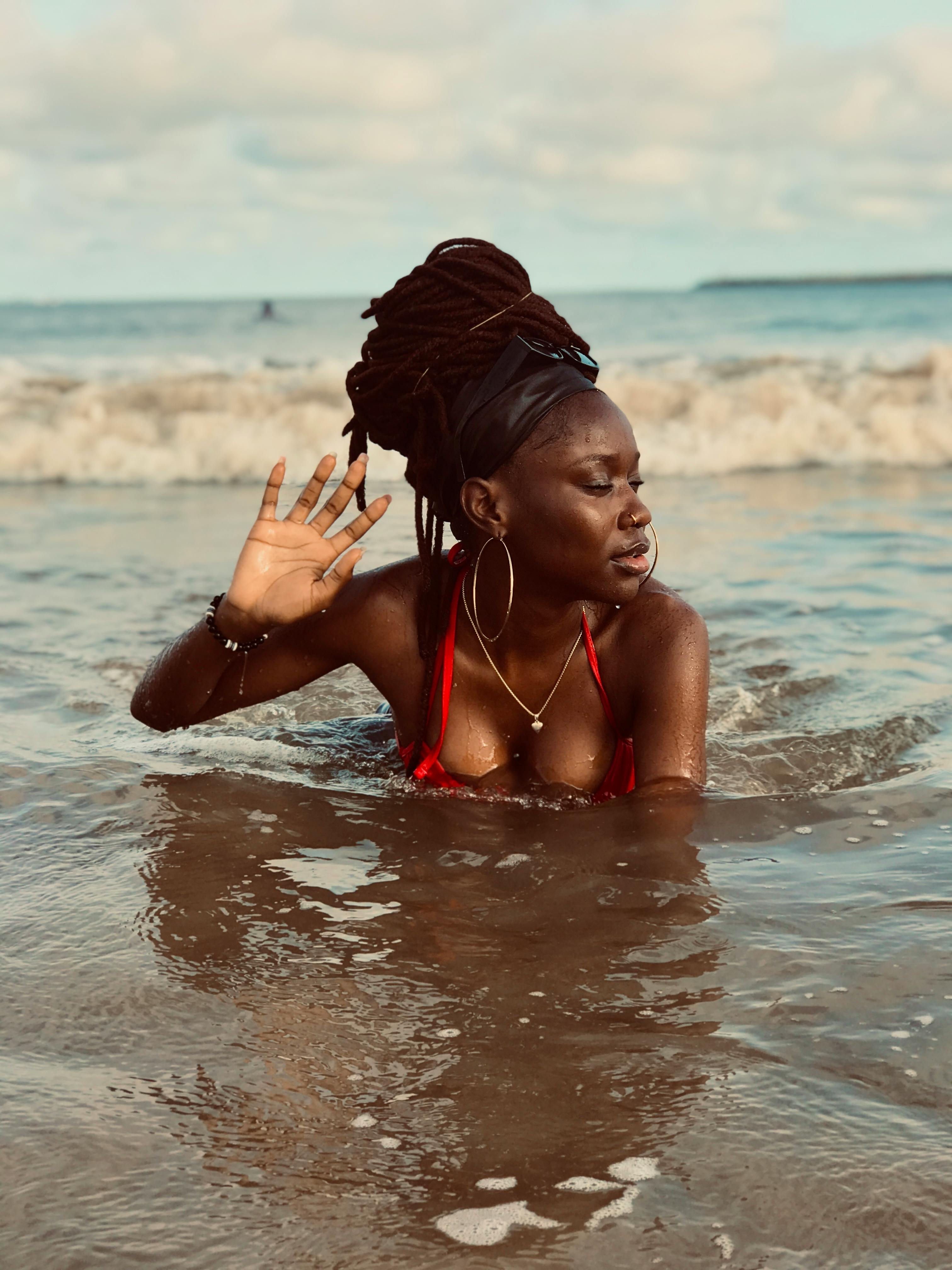 Woman in Red Bikini Lying on Water · Free Stock Photo