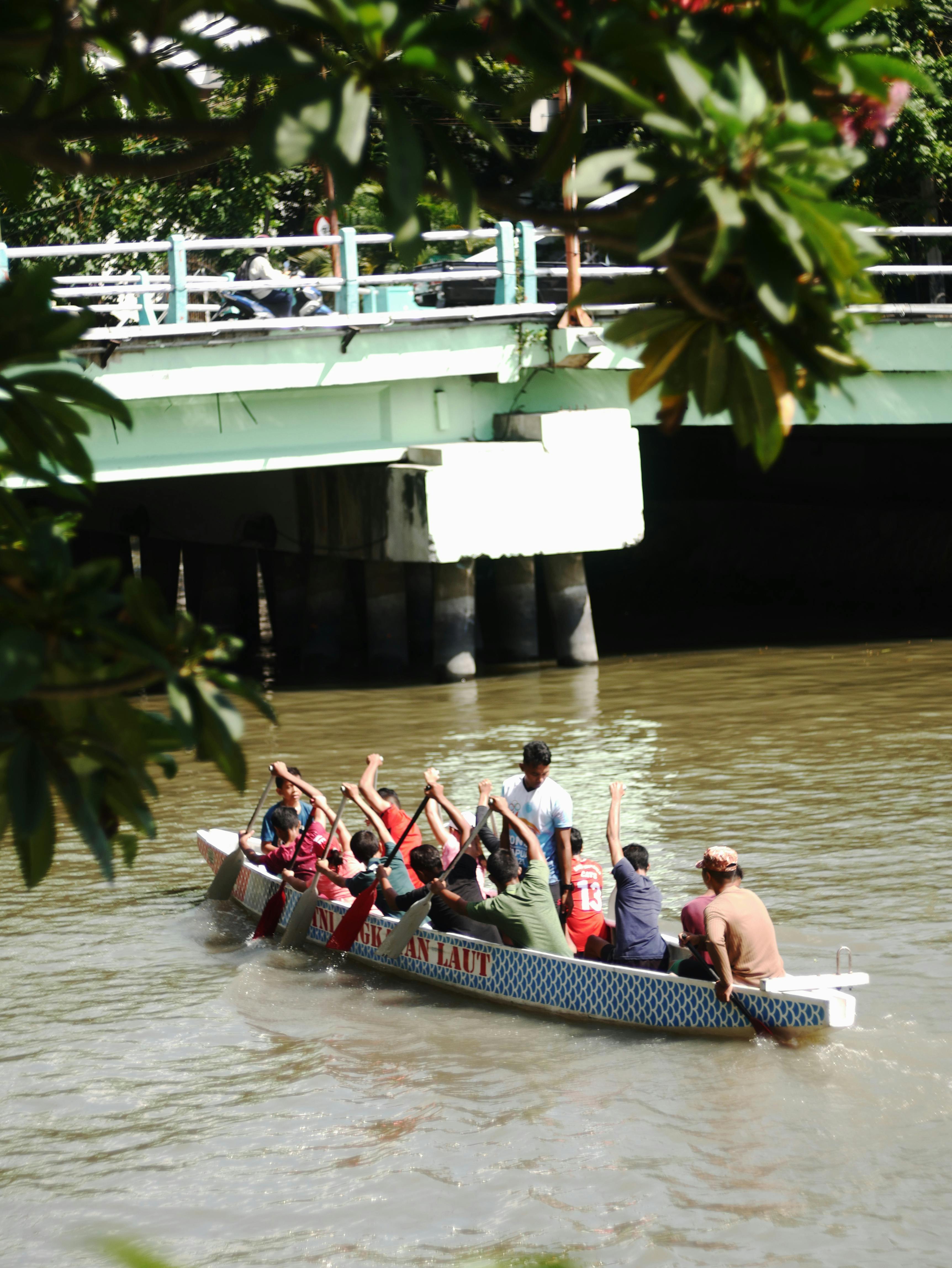 High Angle Shot Of People Rowing Boat · Free Stock Photo
