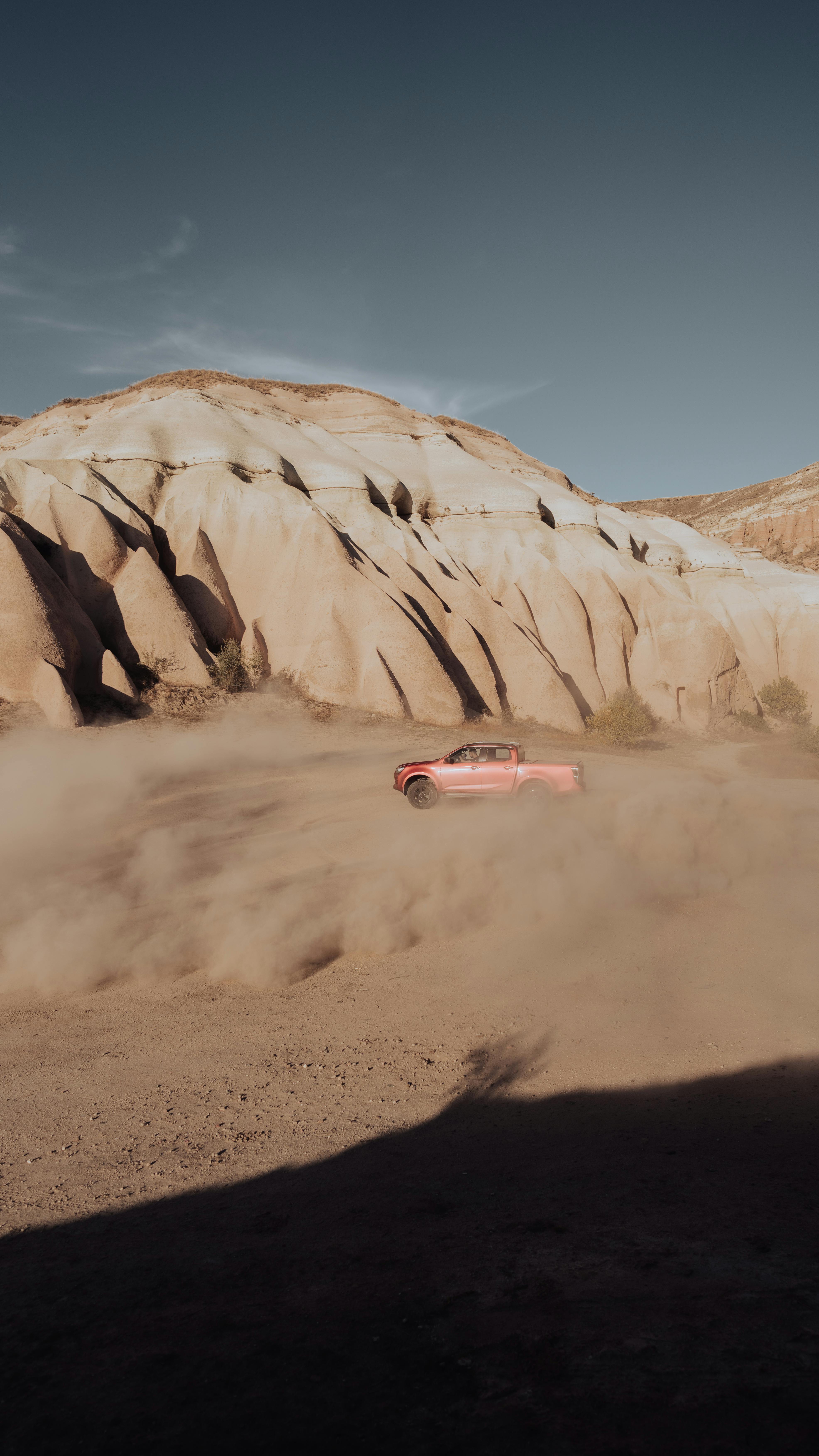 Red Pickup Truck on Brown Sand · Free Stock Photo