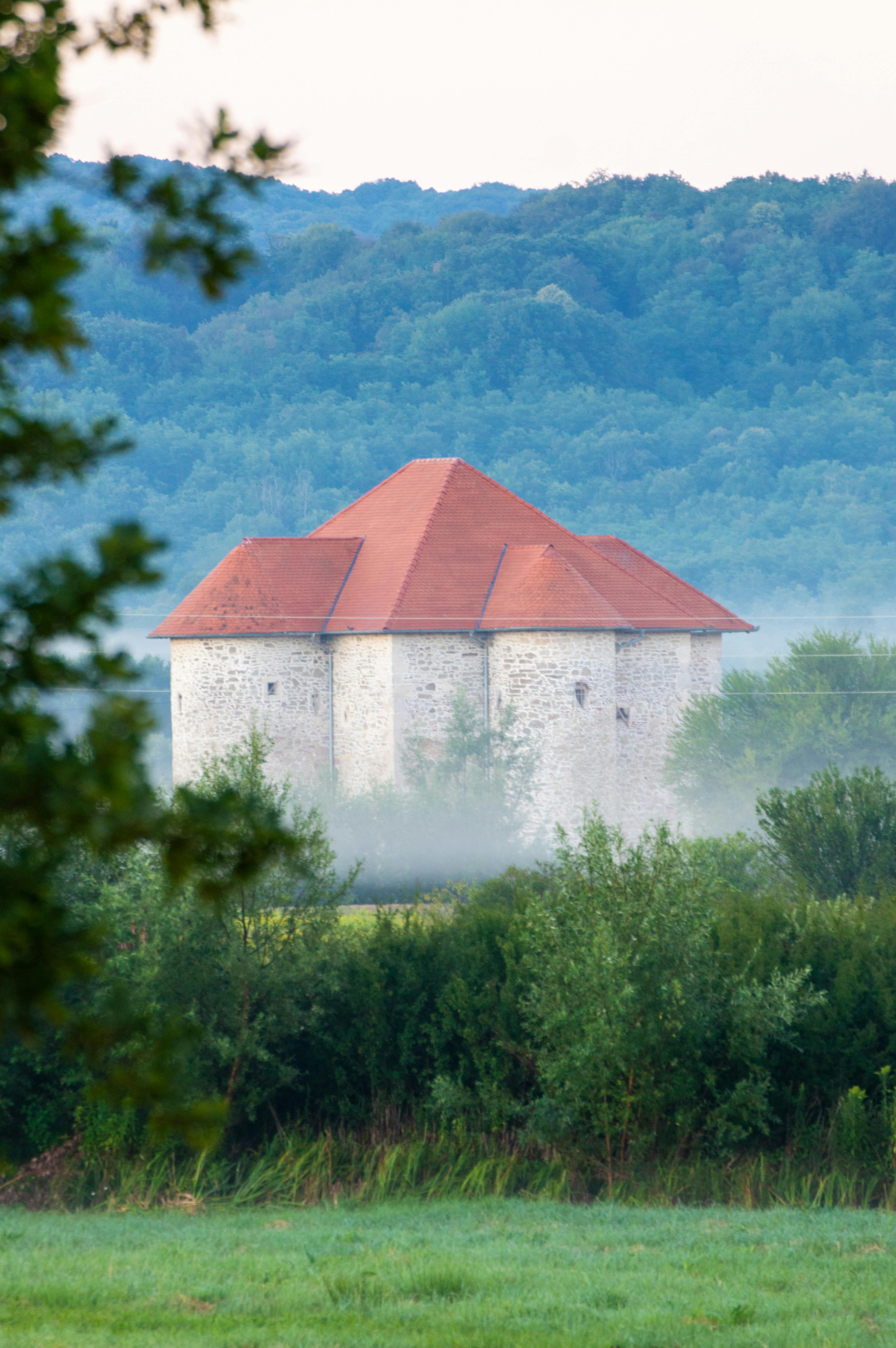Landscape with Trees and a Fortress with Red Roof · Free Stock Photo