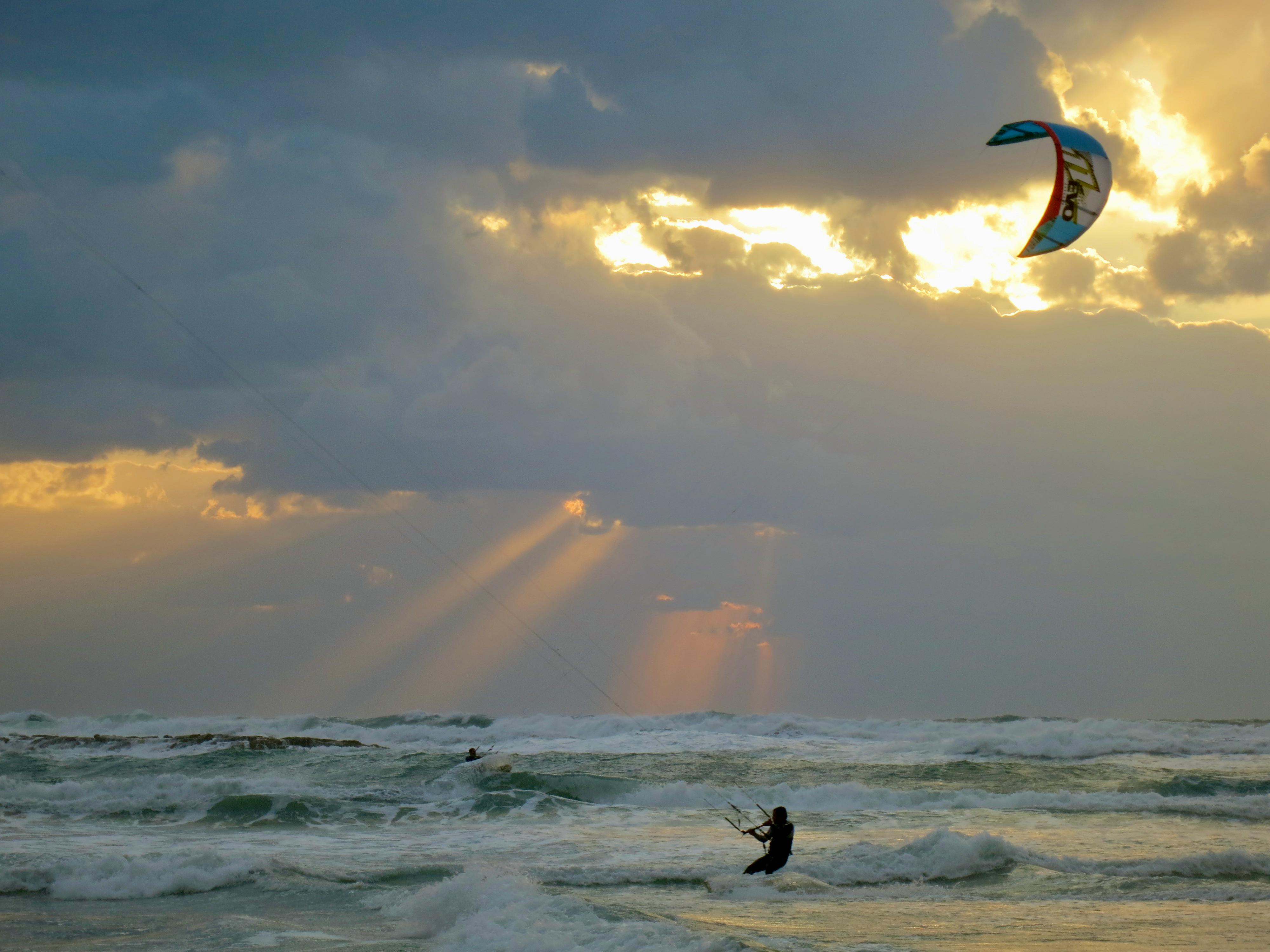 Person Wakeboarding through Sea at Sunset · Free Stock Photo