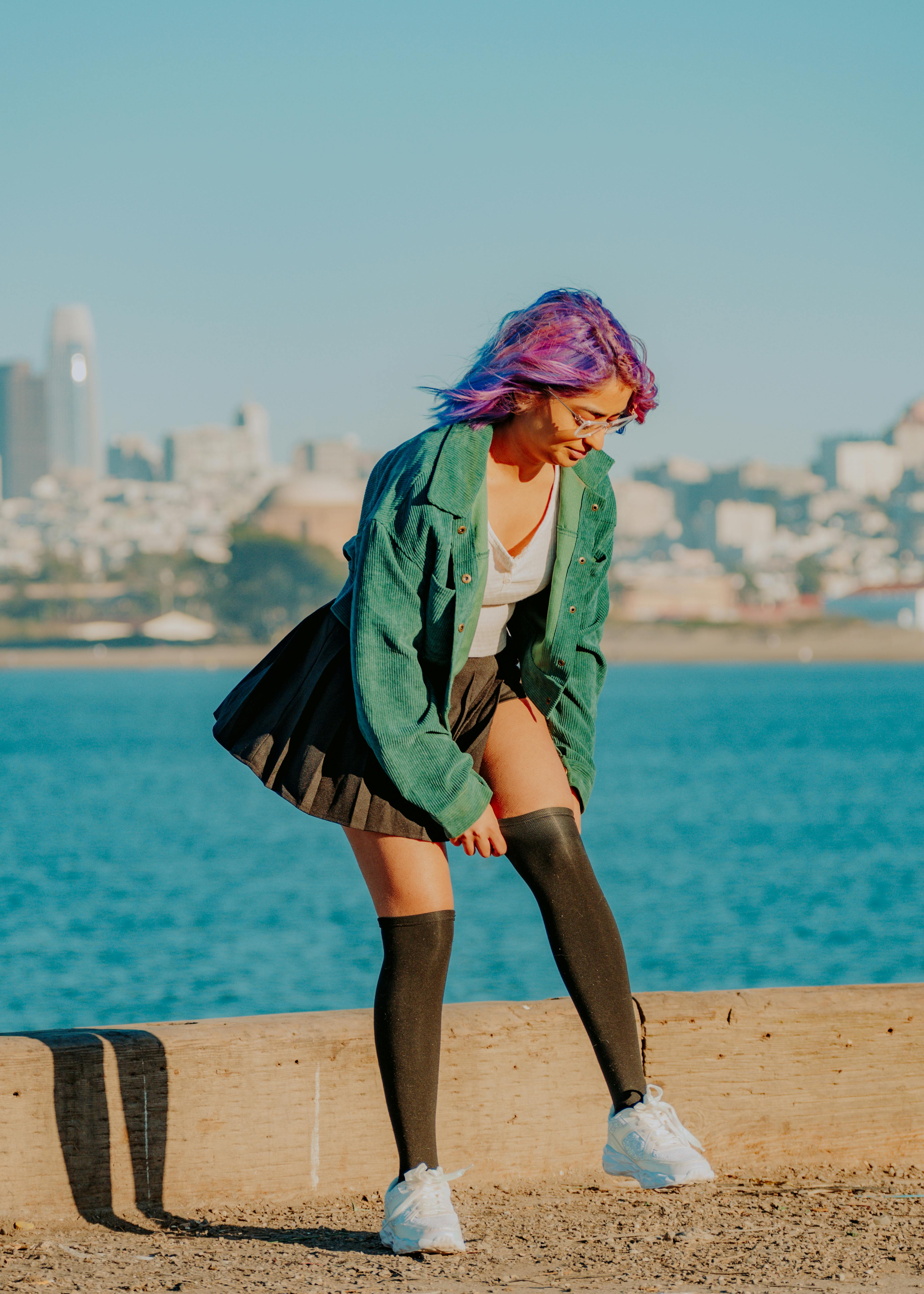 Girl with Purple Hair and Green Jacket Standing by a Blue River · Free ...