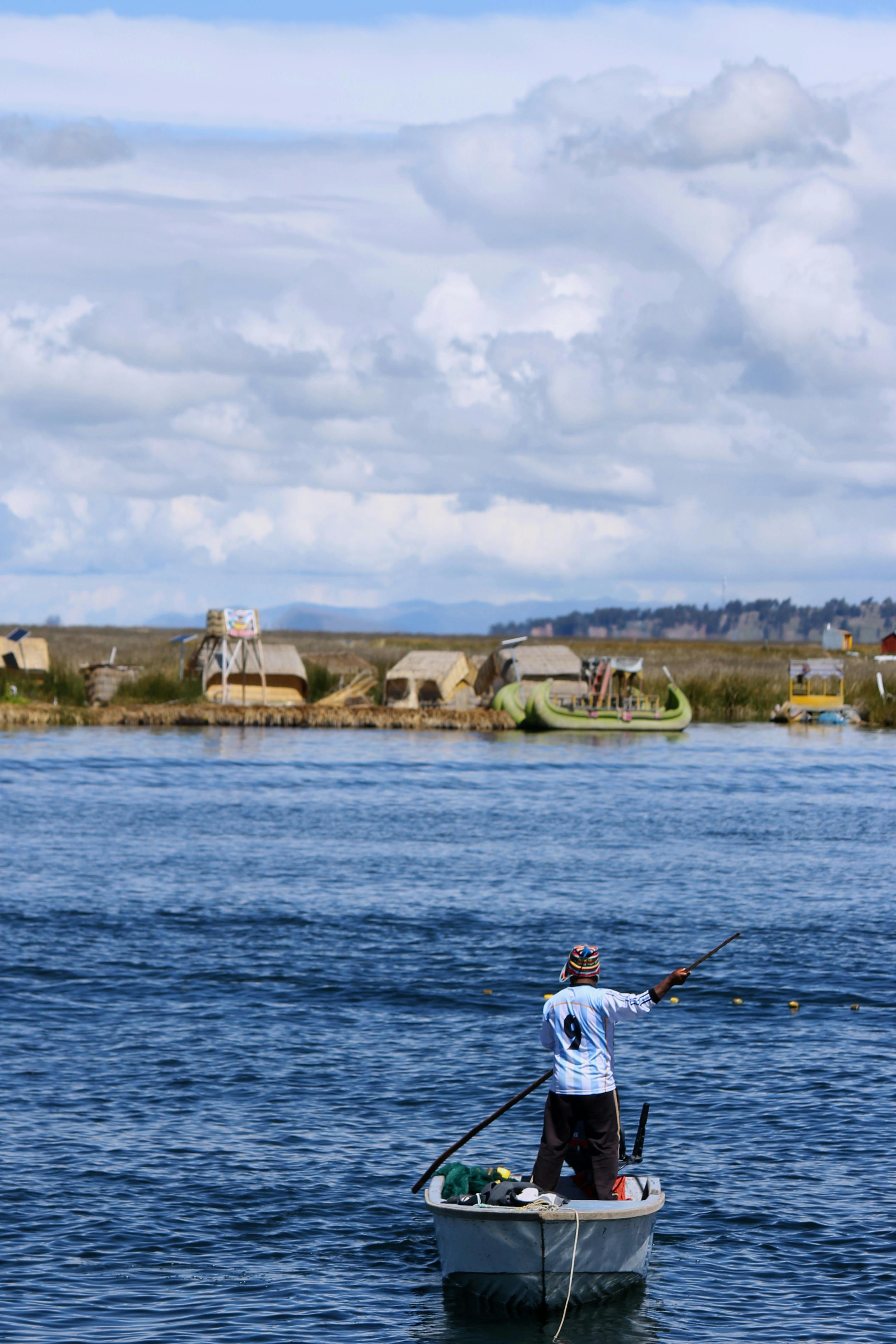 Fisherman Balancing on Boat · Free Stock Photo