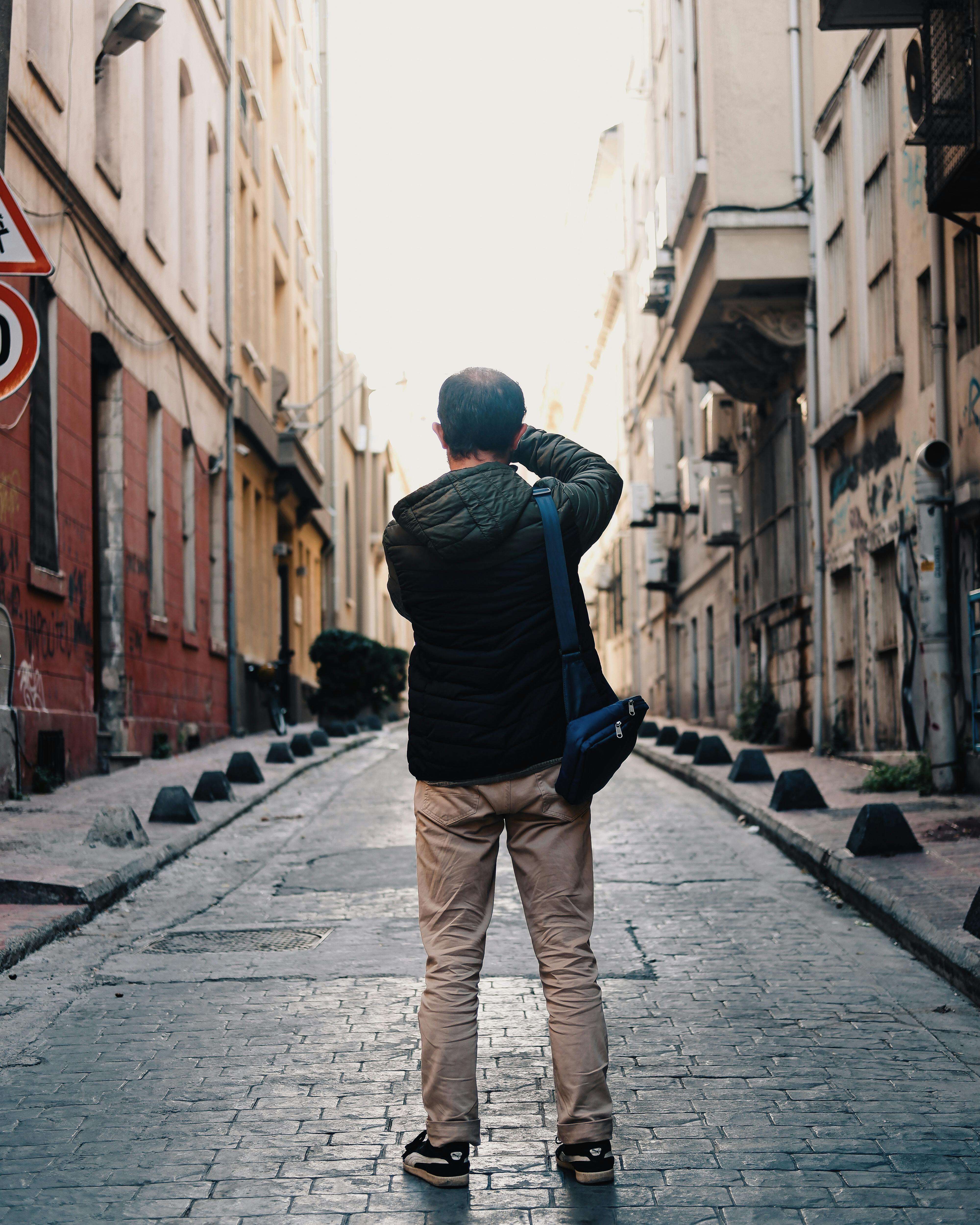 Man Photographing Paved City Street · Free Stock Photo