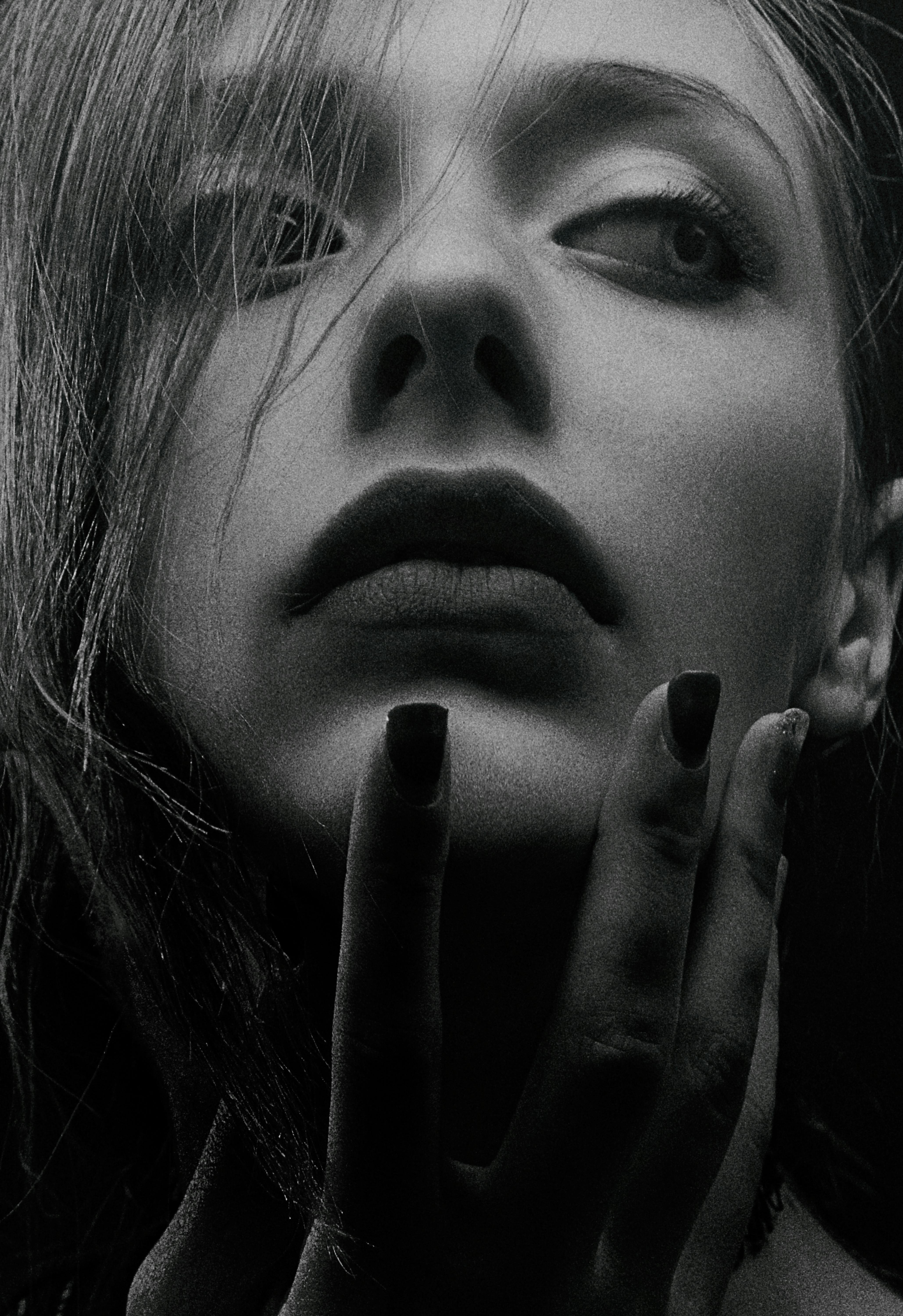 Grayscale Photo of a Woman Touching Her Face · Free Stock Photo