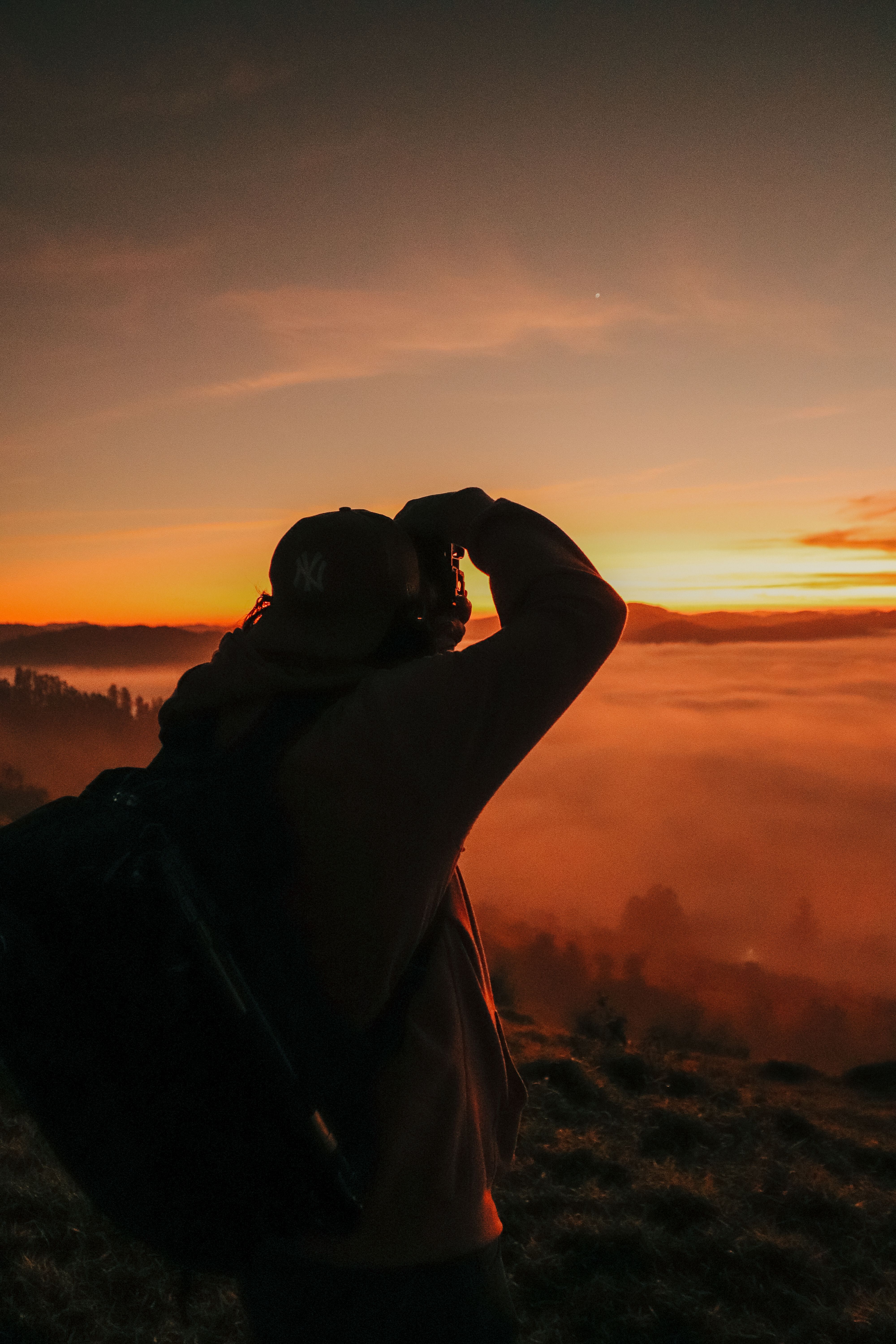 Back of a Man Photographing the Sunset · Free Stock Photo