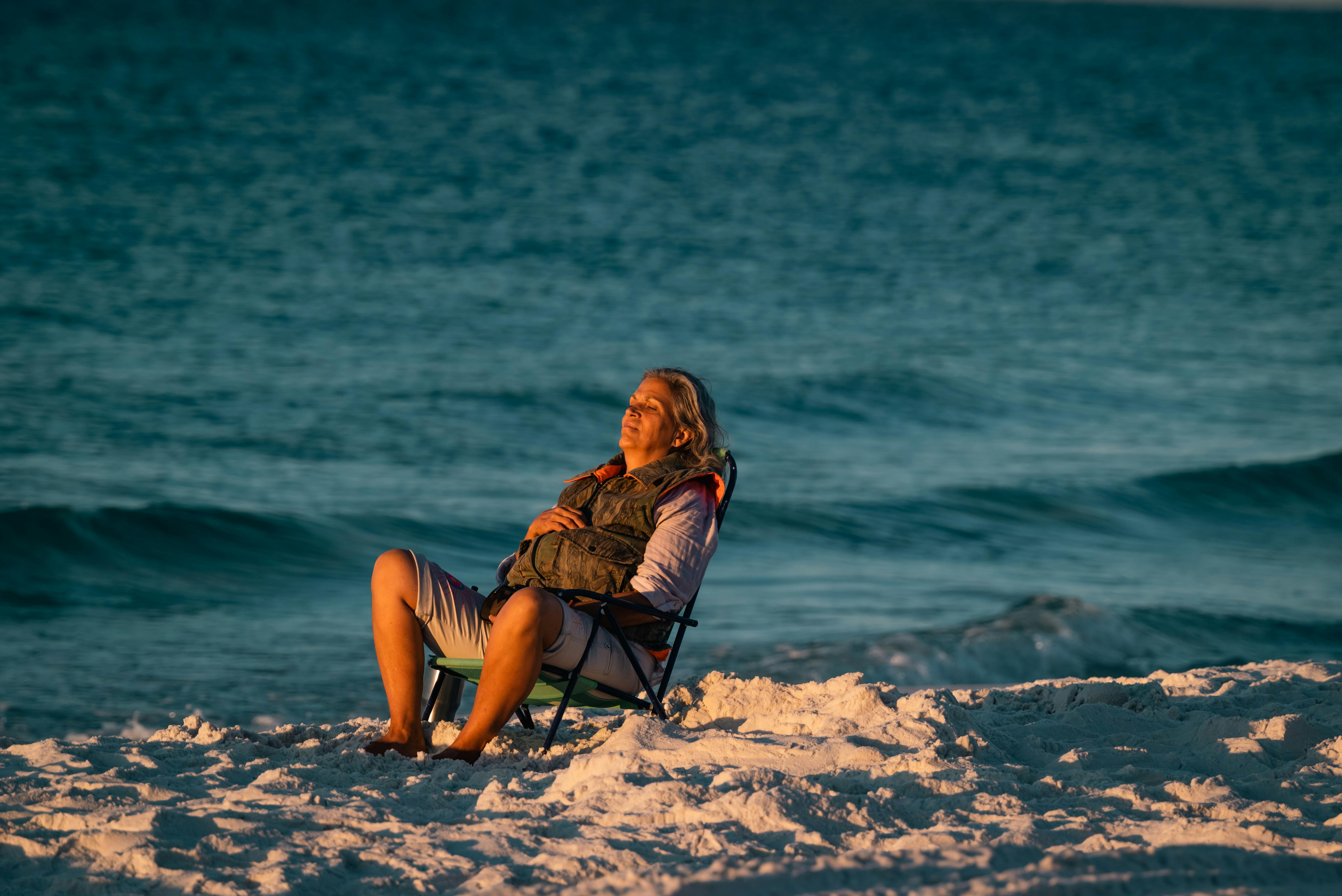 A Woman Sitting on the Beach · Free Stock Photo