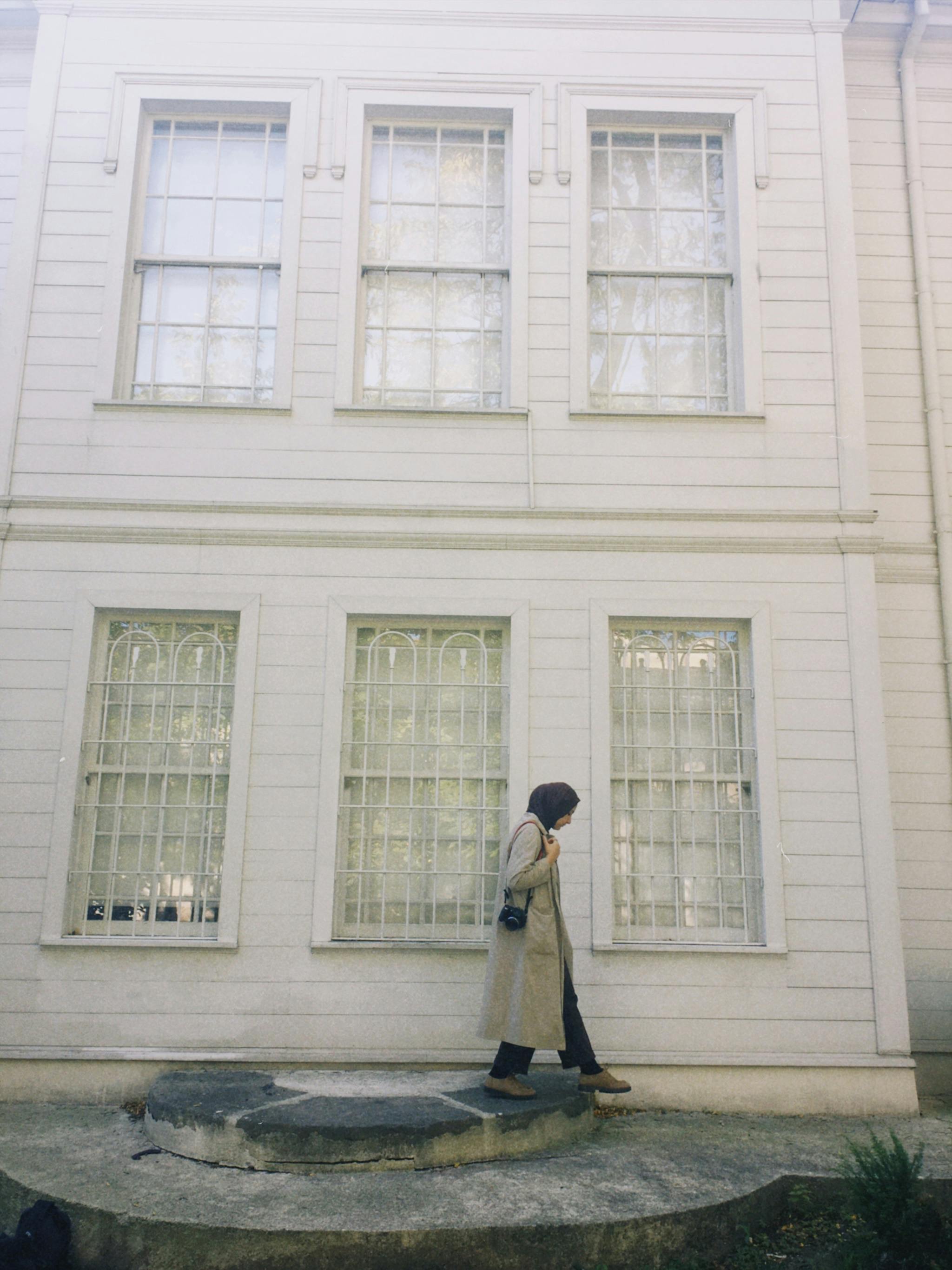 Building Exterior and a Woman Walking by · Free Stock Photo