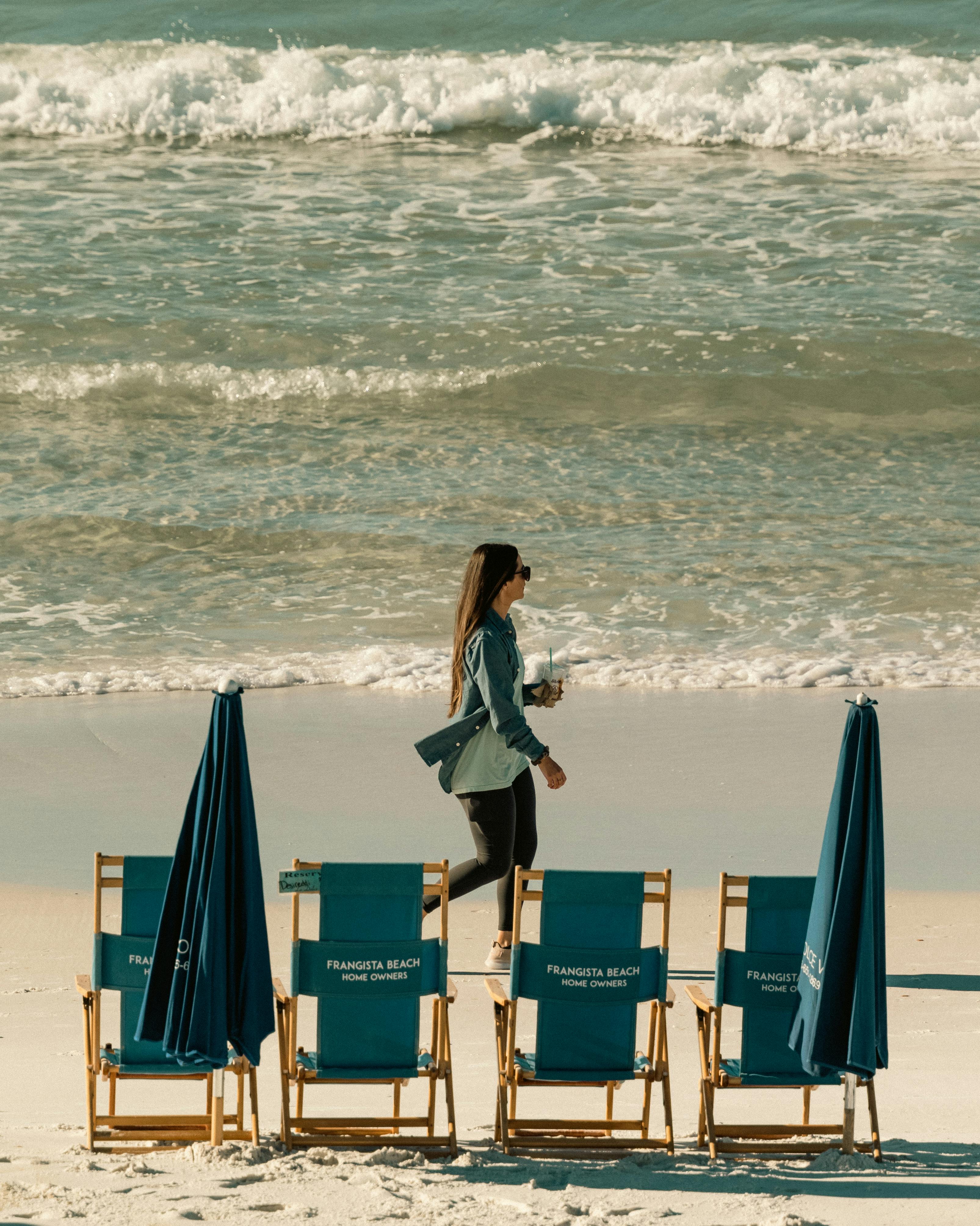 Woman Walking on the Beach Shore · Free Stock Photo