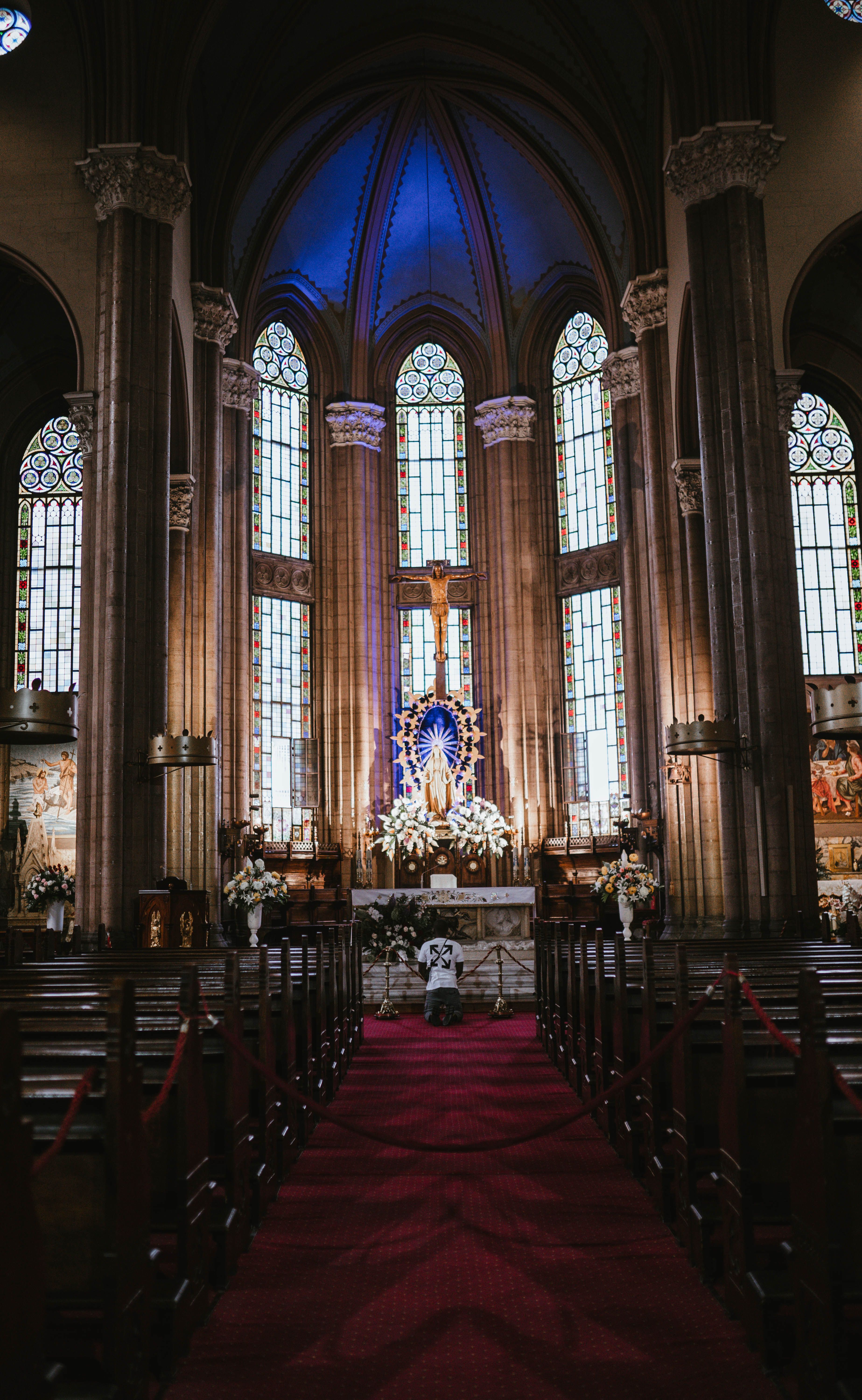 A Man Kneeling in Front of the Altar · Free Stock Photo
