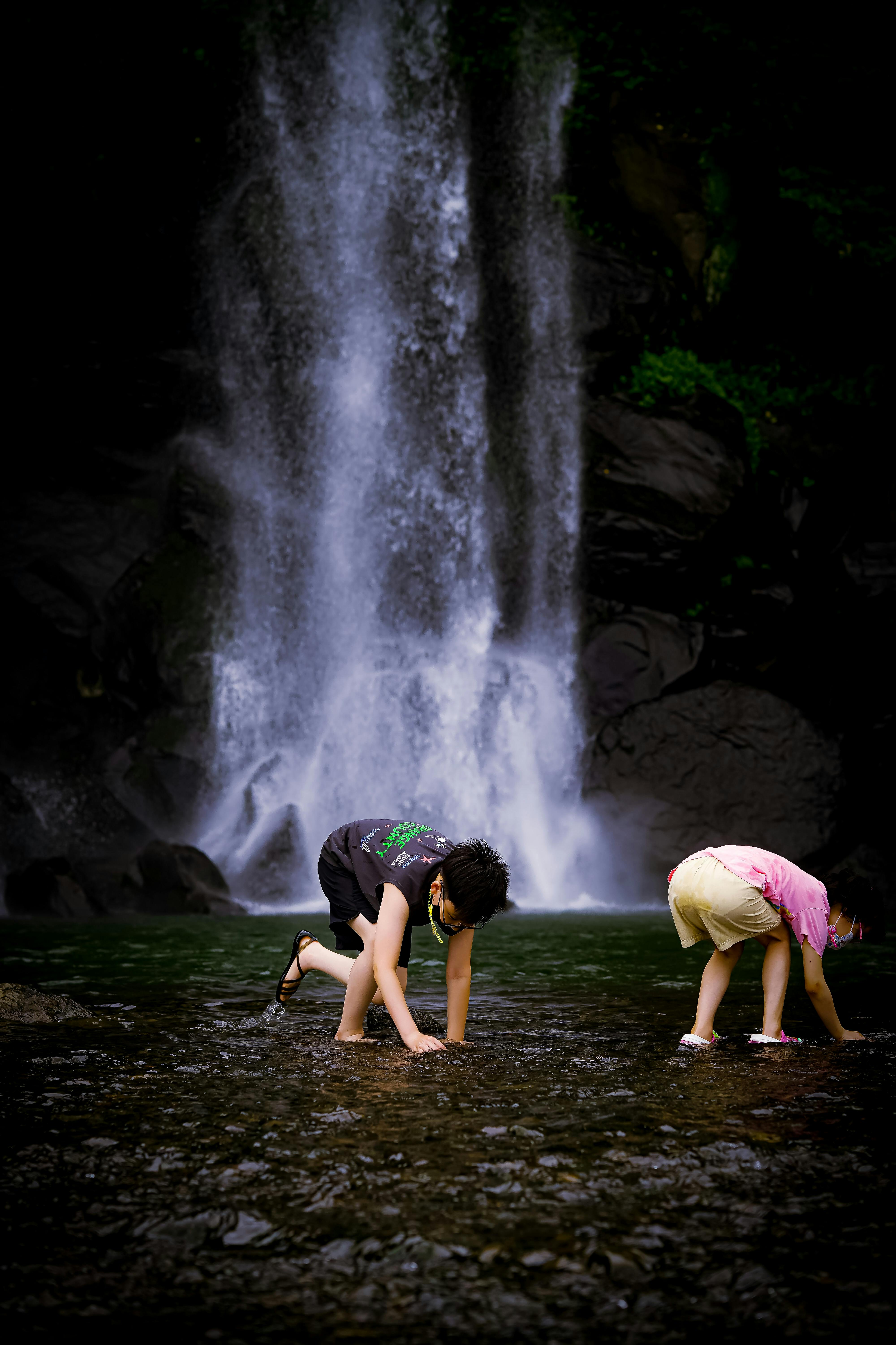 Kids Playing in Stream Near Waterfall · Free Stock Photo