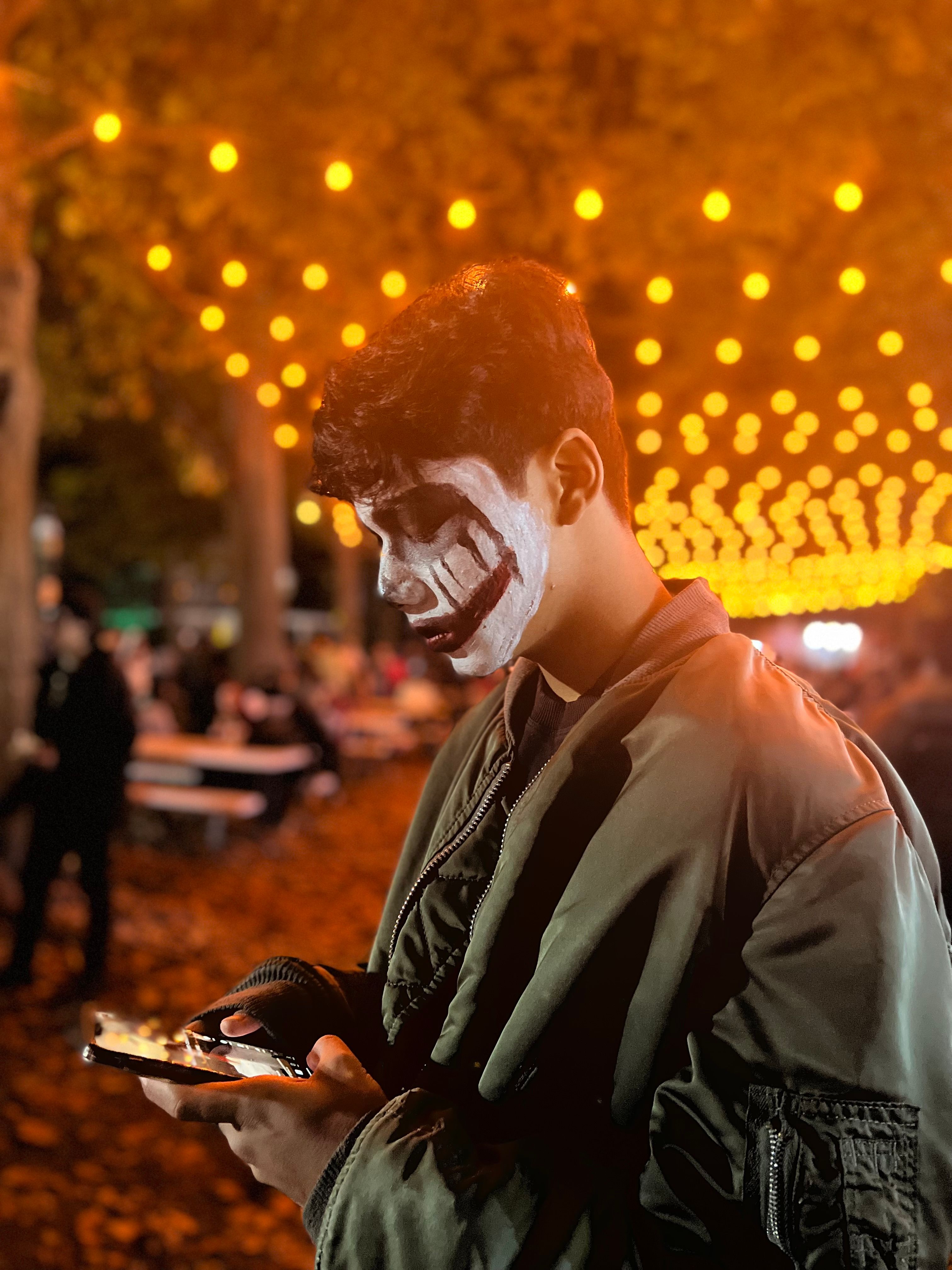 Man with a Death Mask Painting on his Face Using his Smart Phone · Free ...