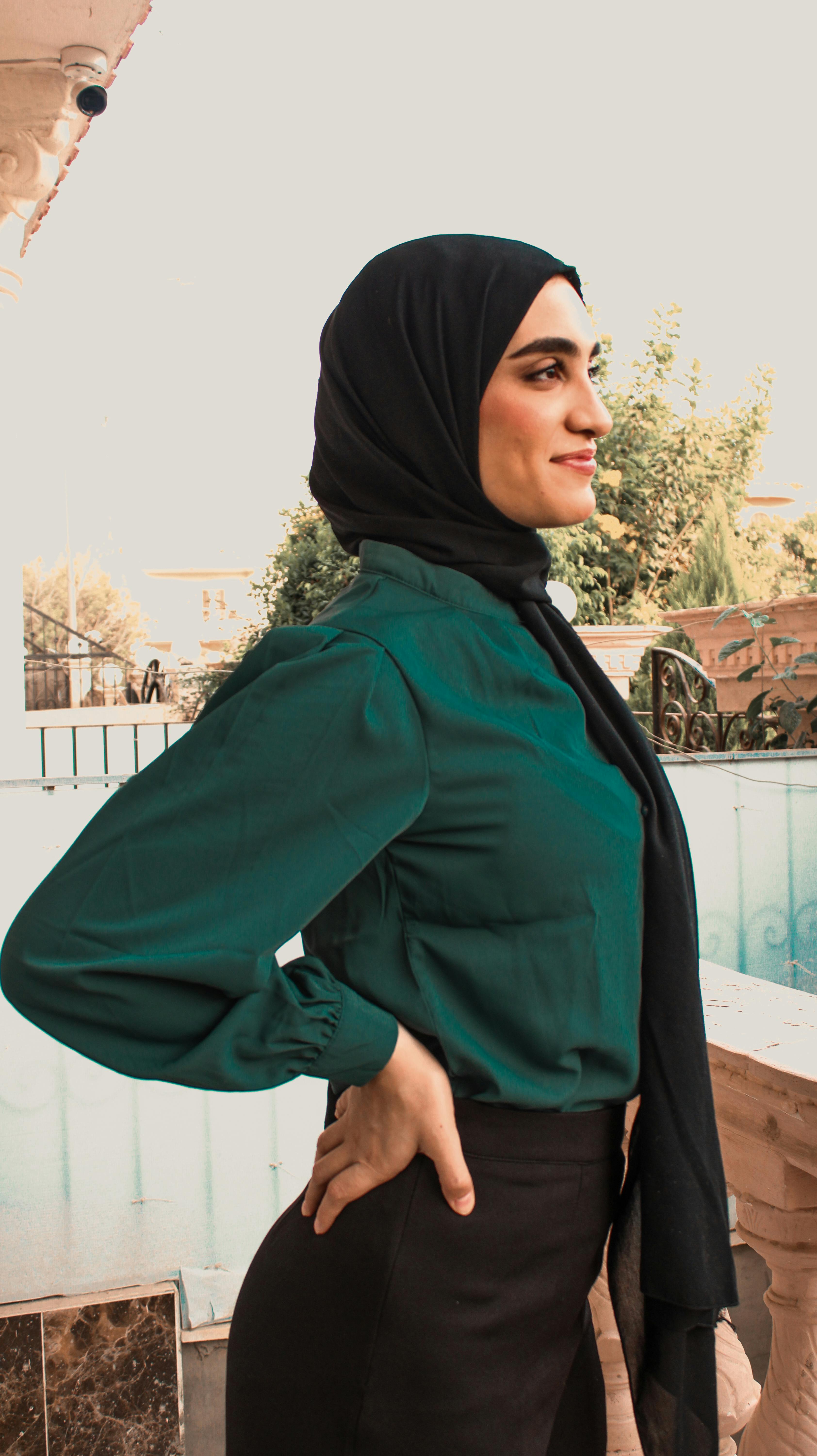 A Woman Wearing Black Hijab and Green Long Sleeves · Free Stock Photo