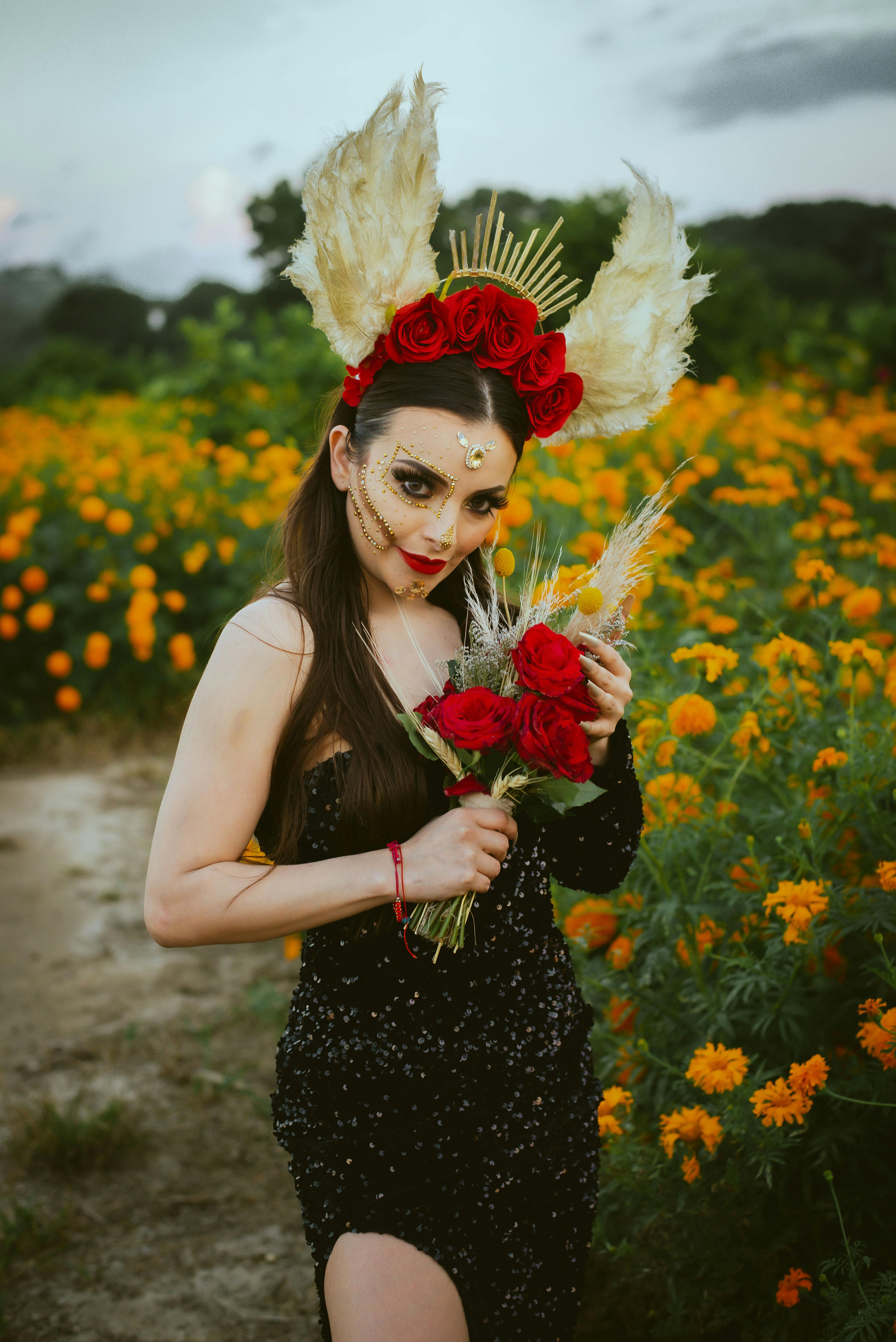 Woman Wearing a Headdress with Red Roses and Feathers · Free Stock Photo