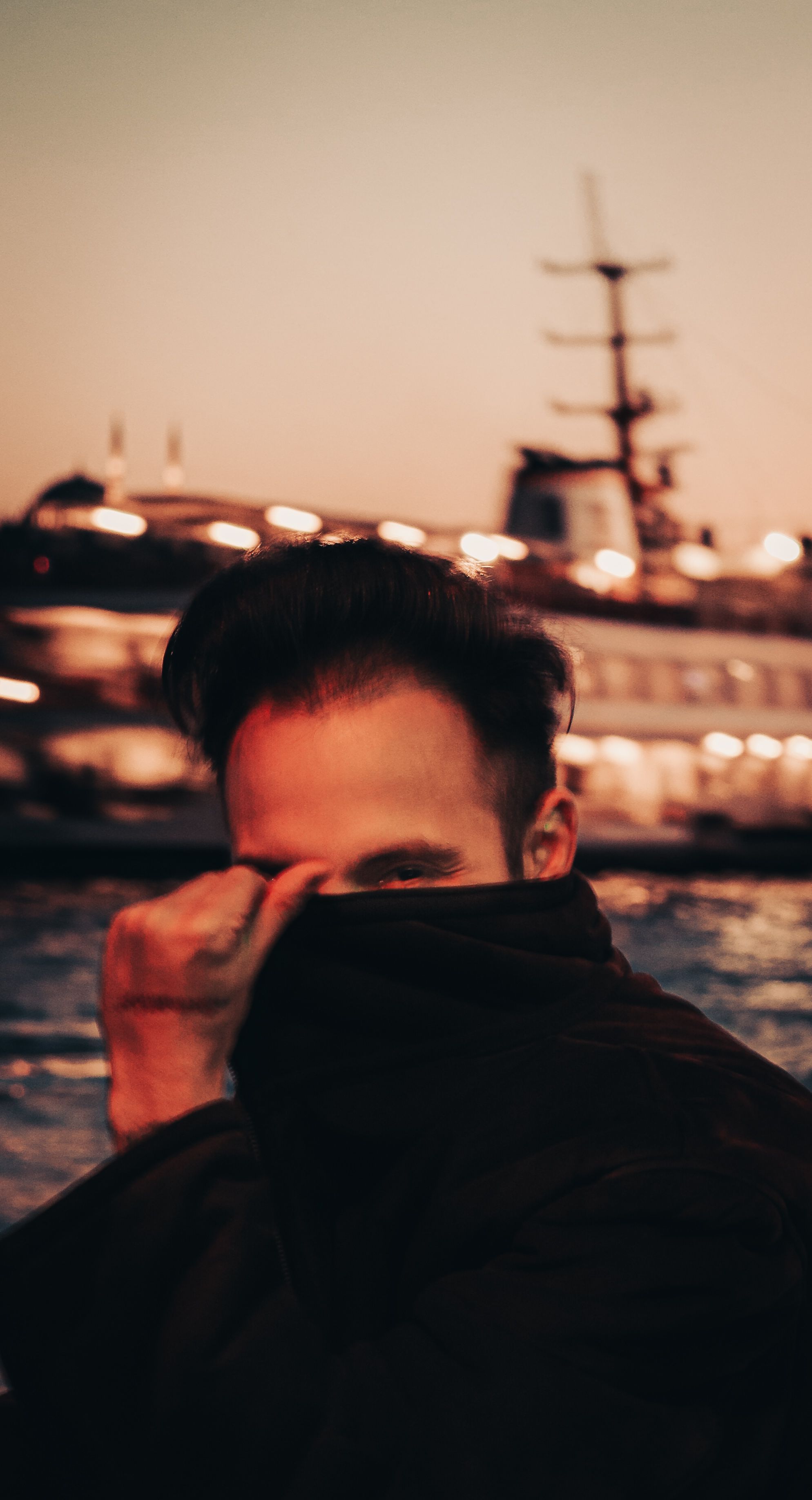 A Man in Black Jacket Covering His Face With His Jacket · Free Stock Photo