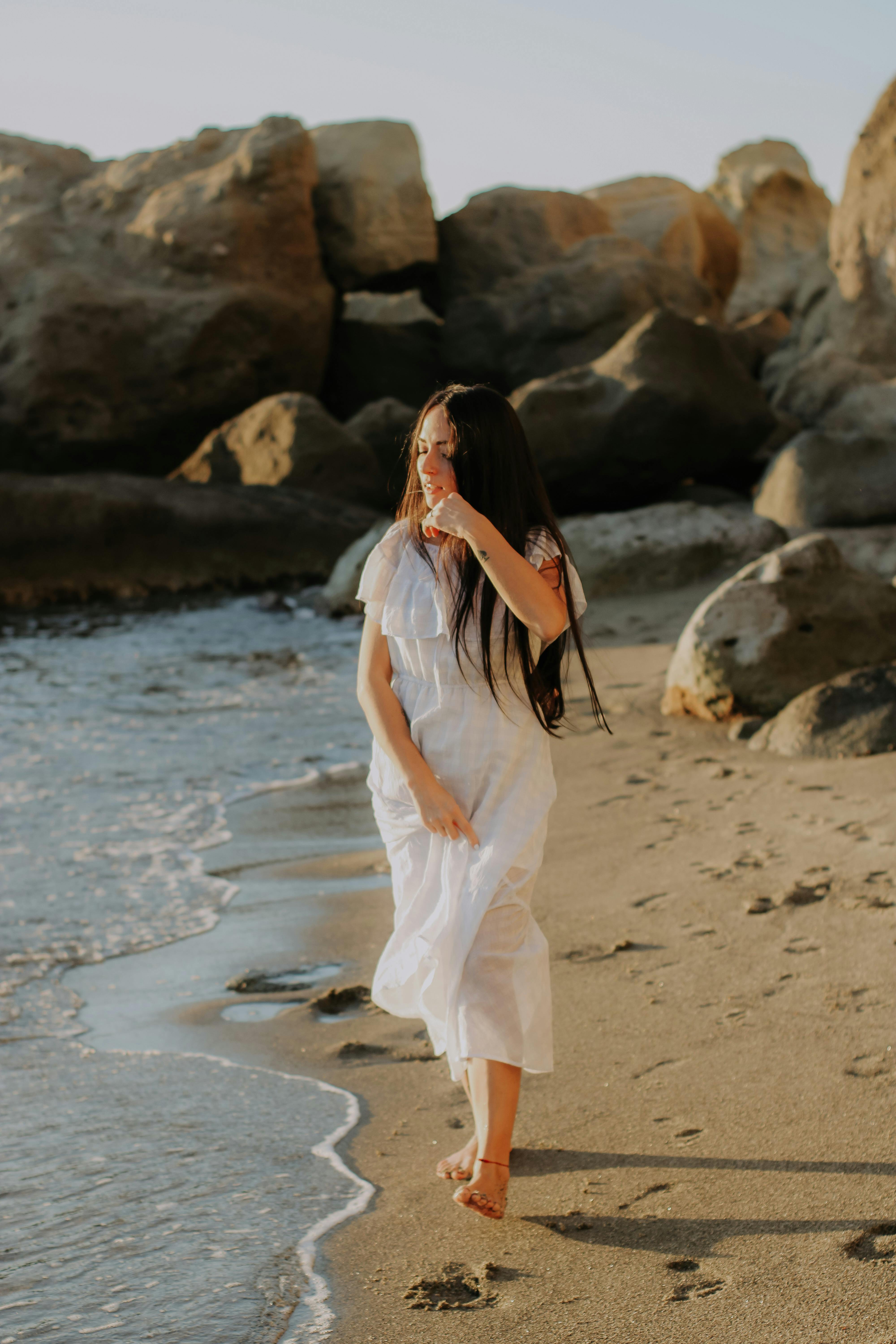 A Woman Walking on the Shore · Free Stock Photo