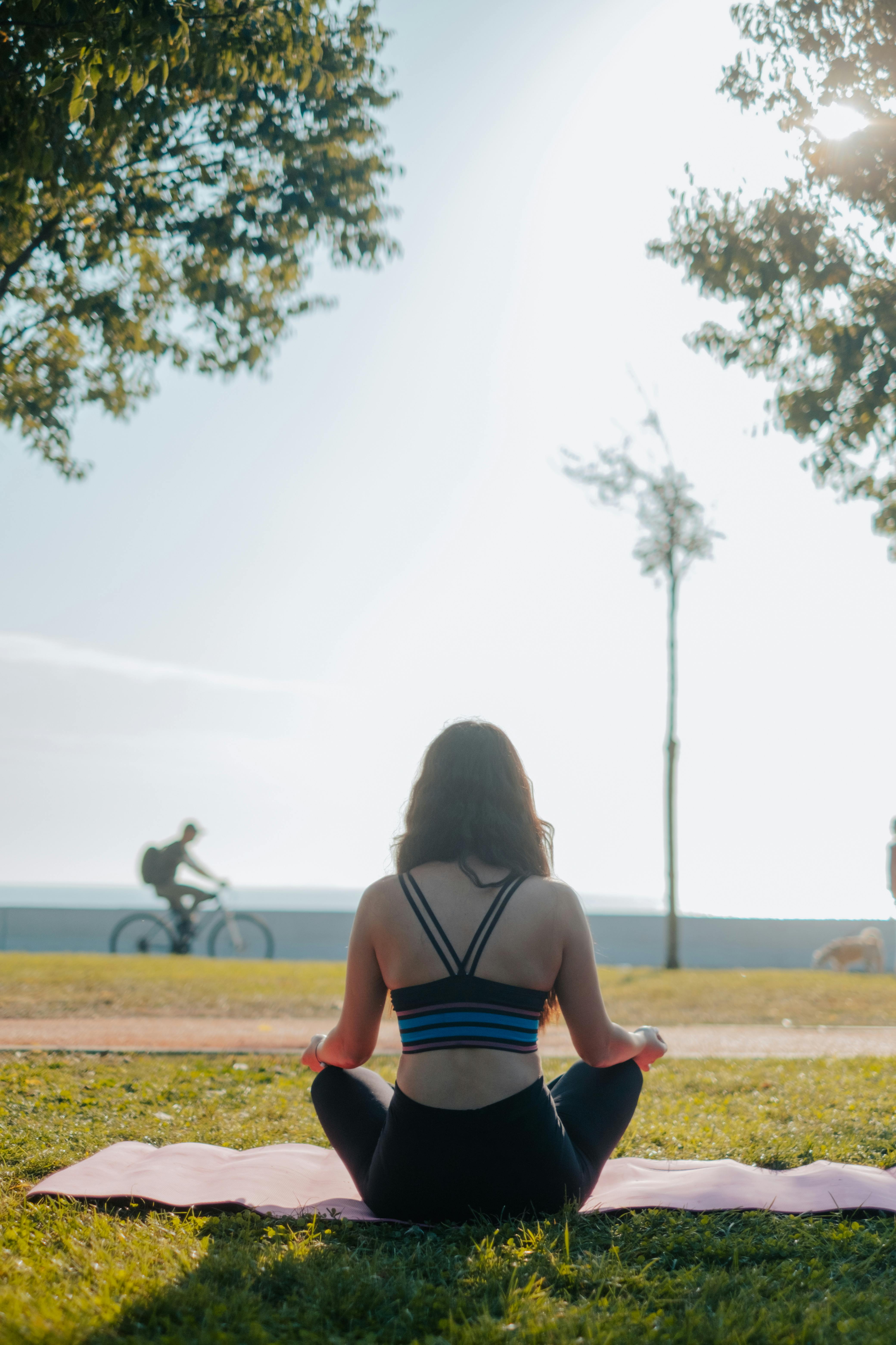 A Woman Doing Yoga on Green Grass Field · Free Stock Photo
