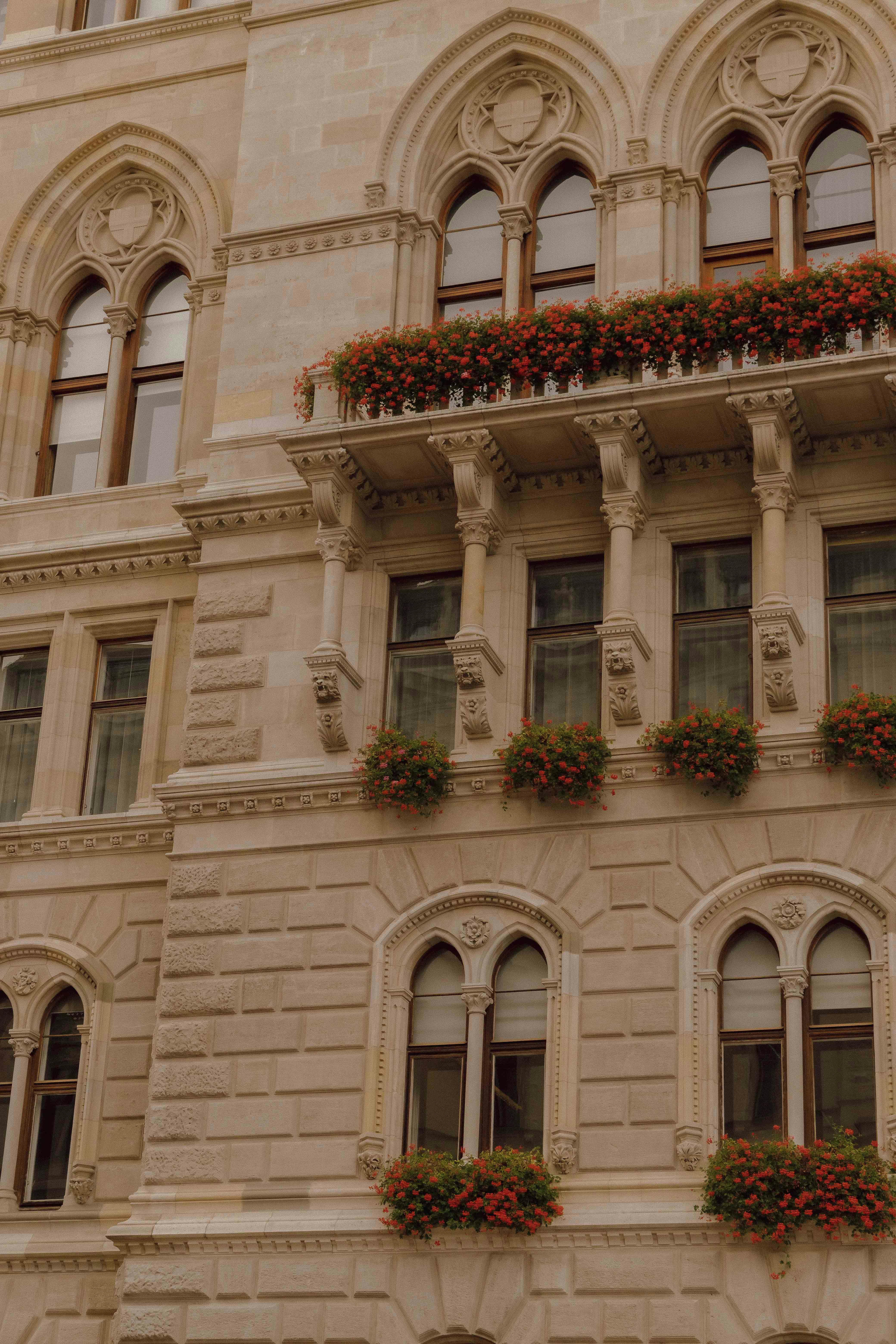Beige Concrete Building with Arched Glass Windows · Free Stock Photo