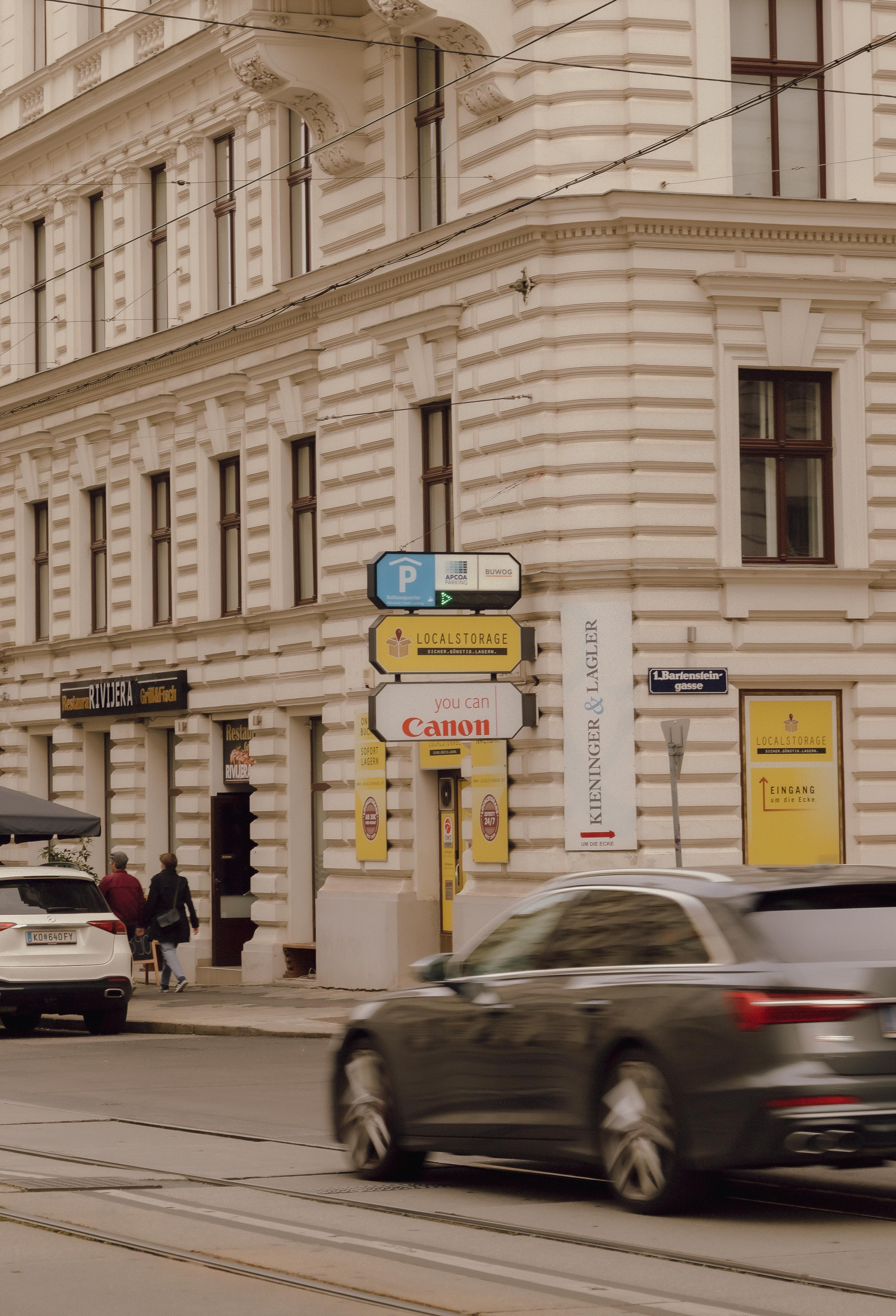 Concrete Building by the Road with Cars · Free Stock Photo