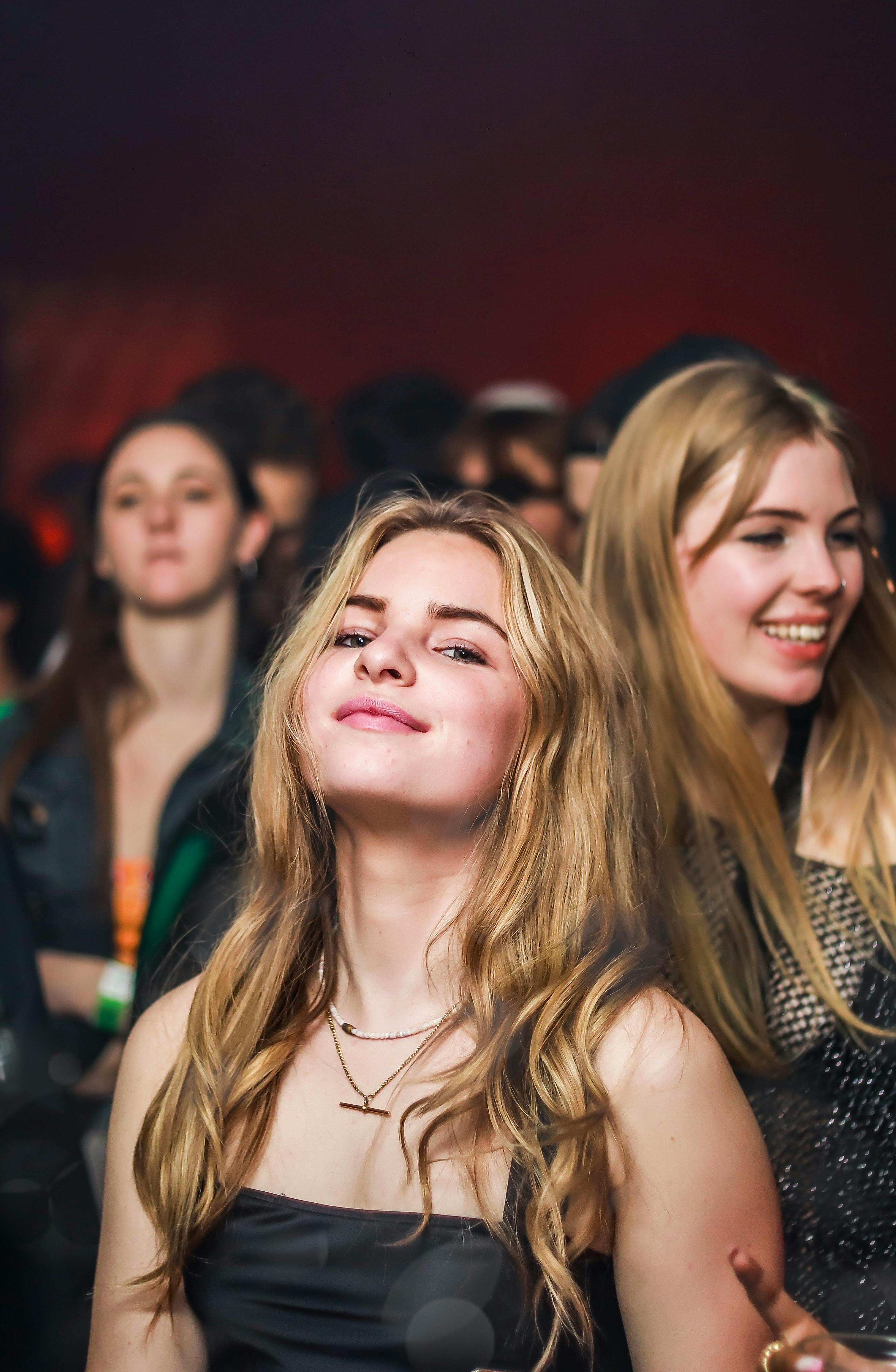 Smug Elegant Woman in Crowd · Free Stock Photo