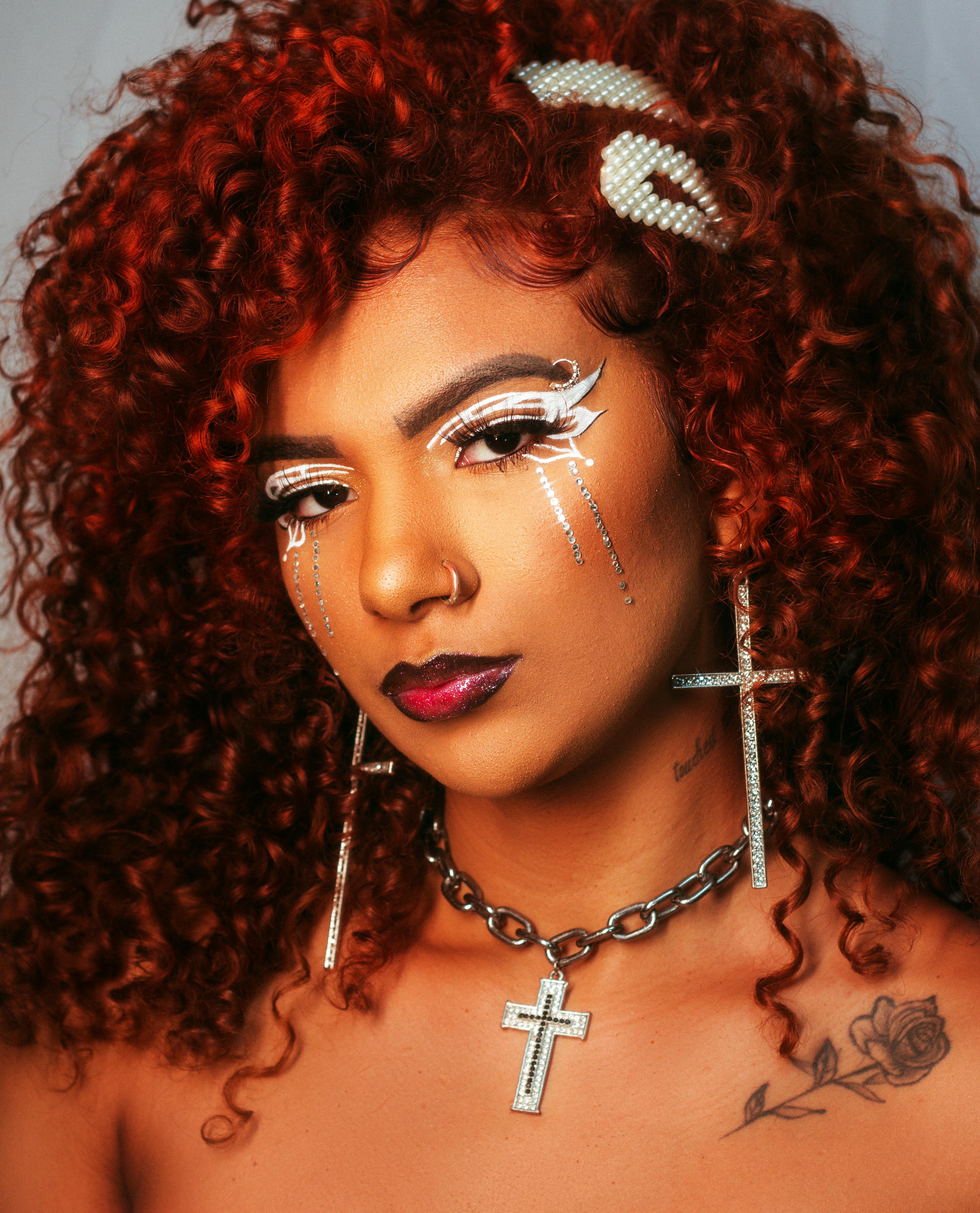 Portrait of Woman Wearing Cross Necklace and Earrings · Free Stock Photo