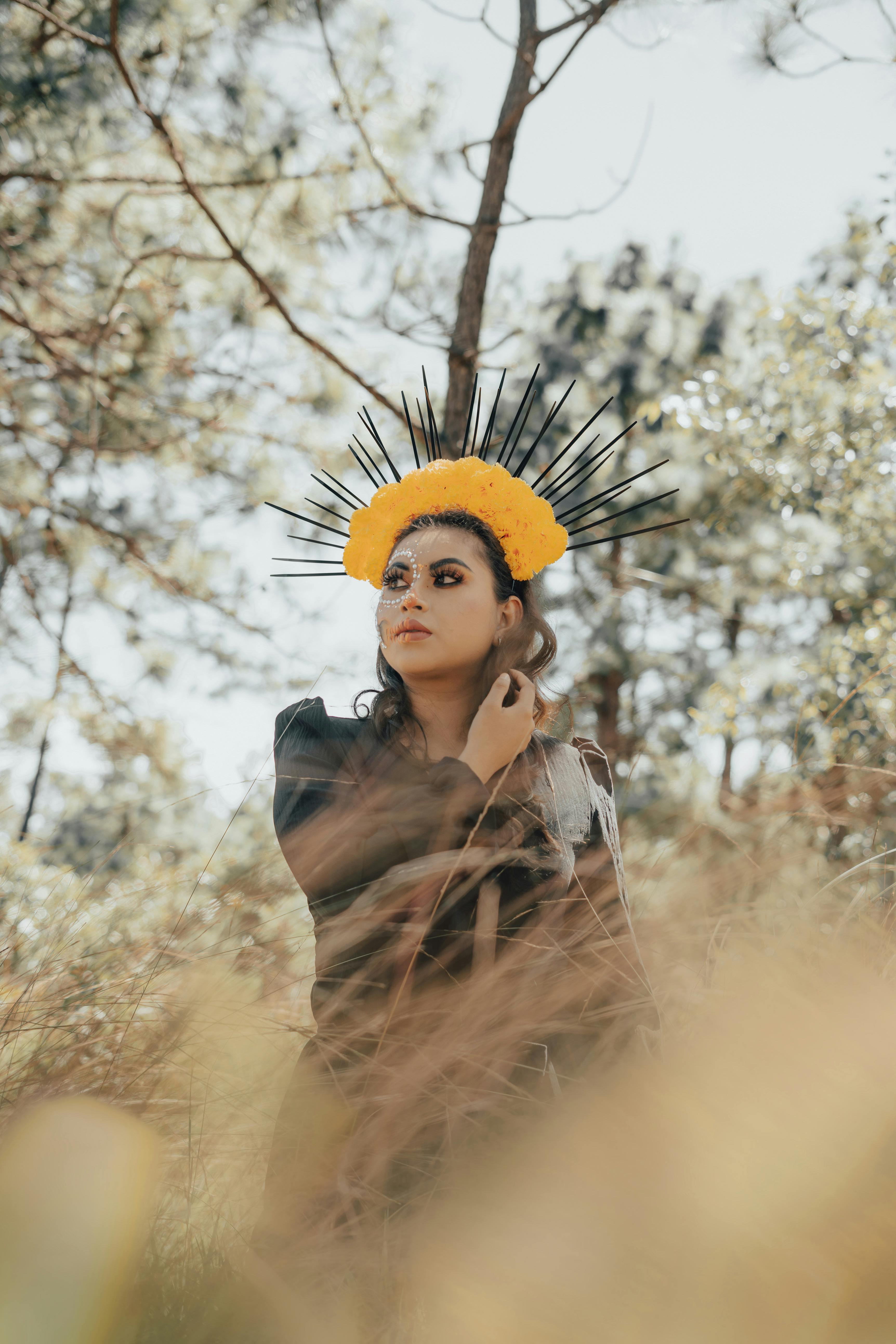 A Woman Wearing a Black Dress and a Floral Headdress in a Forest · Free ...
