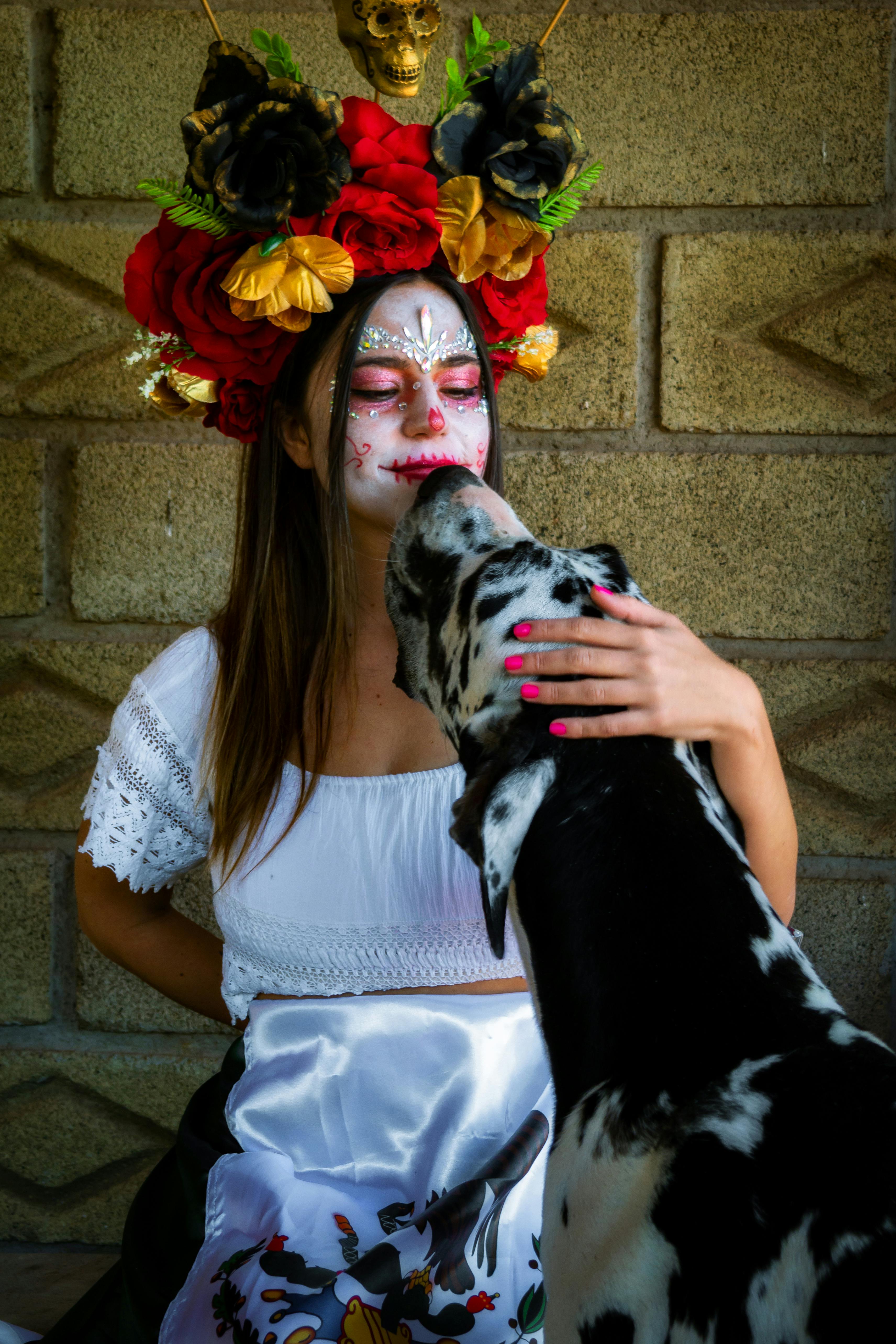 A Dog Kissing a Woman in Catrina Makeup · Free Stock Photo