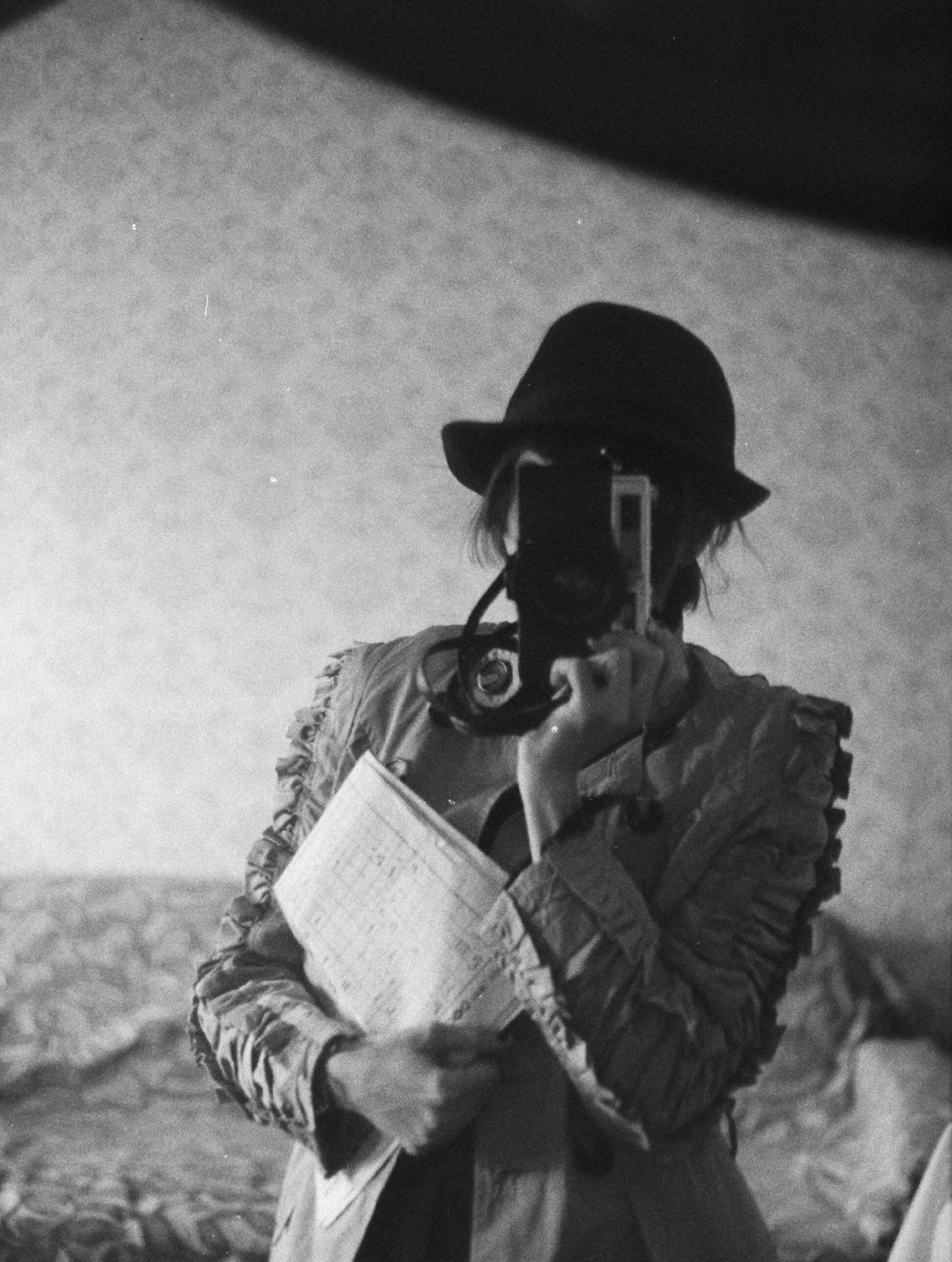 Man in Black Hat Holding Camera · Free Stock Photo