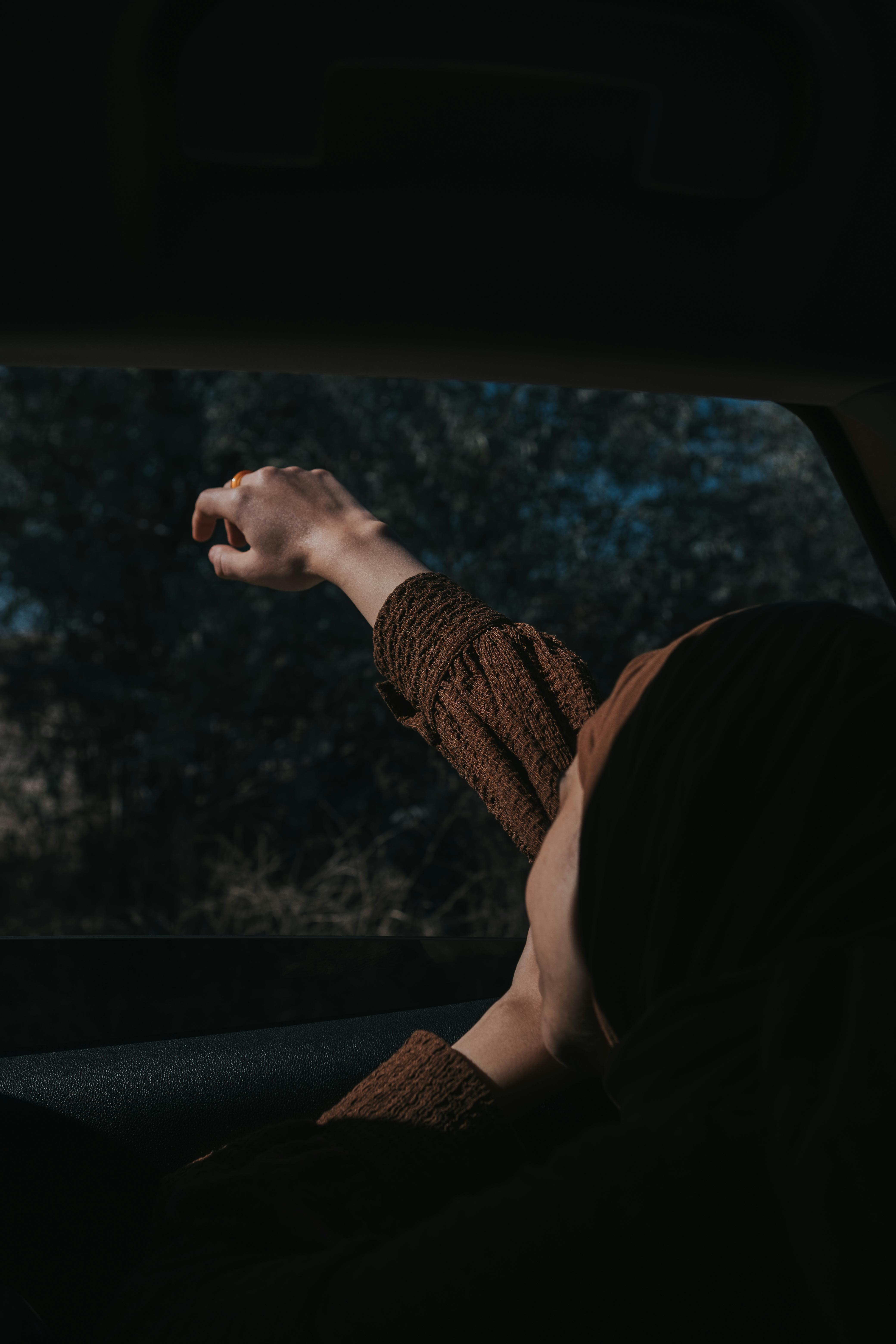 Person Reaching Outside a Car Window · Free Stock Photo