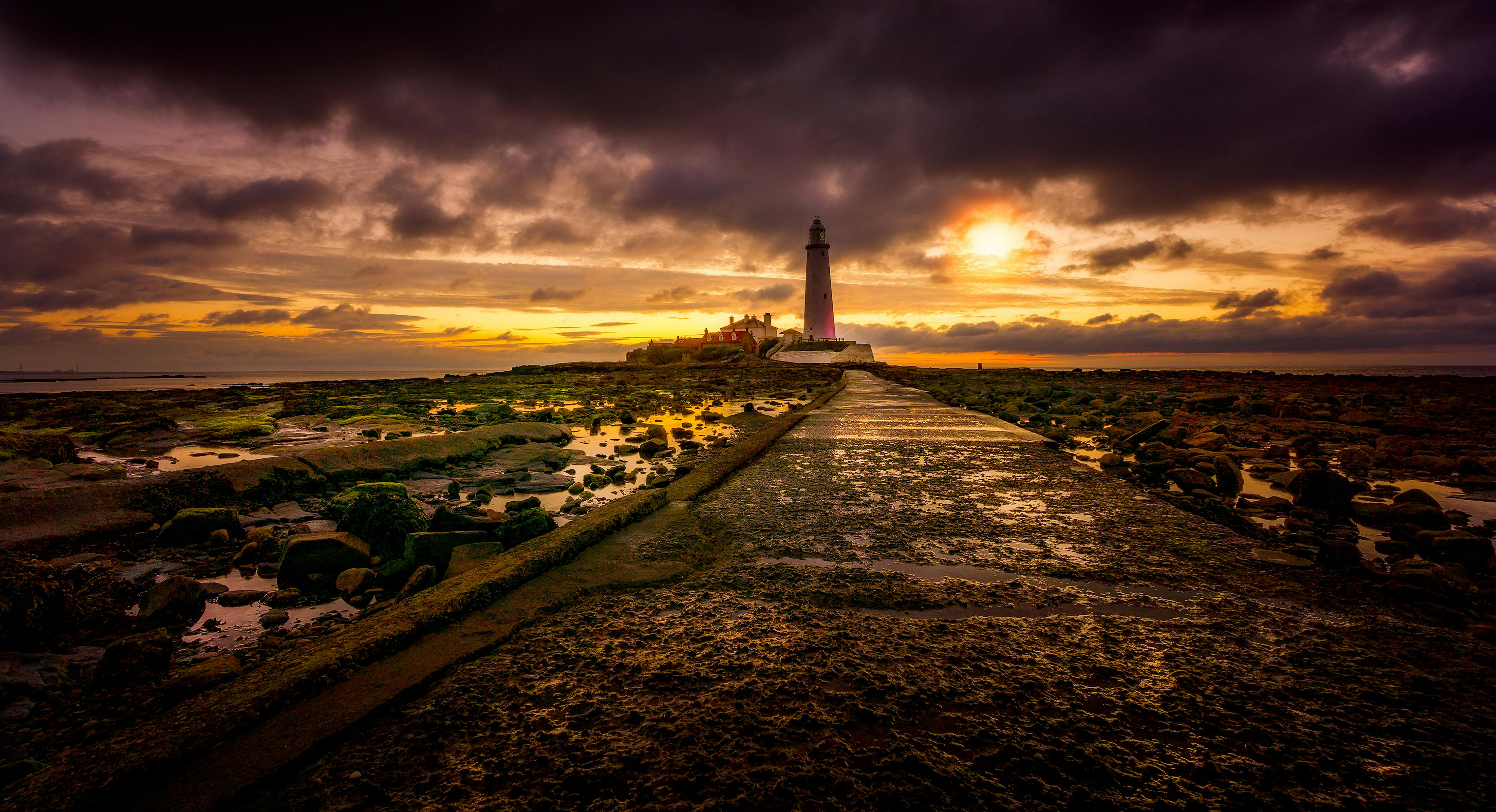 Photo of Sunset over a Lighthouse · Free Stock Photo