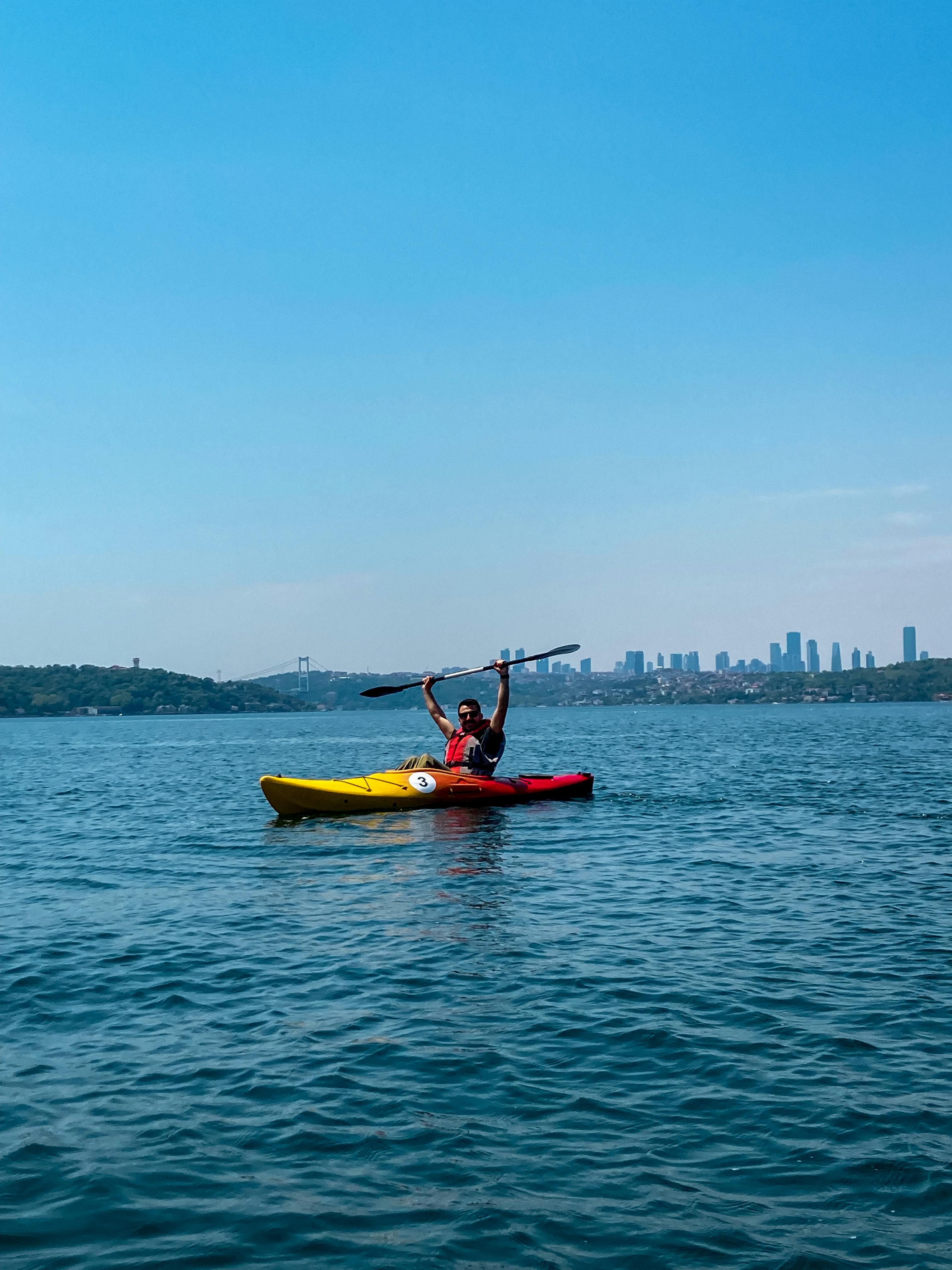 Man in a Kayak Raising His Paddle · Free Stock Photo