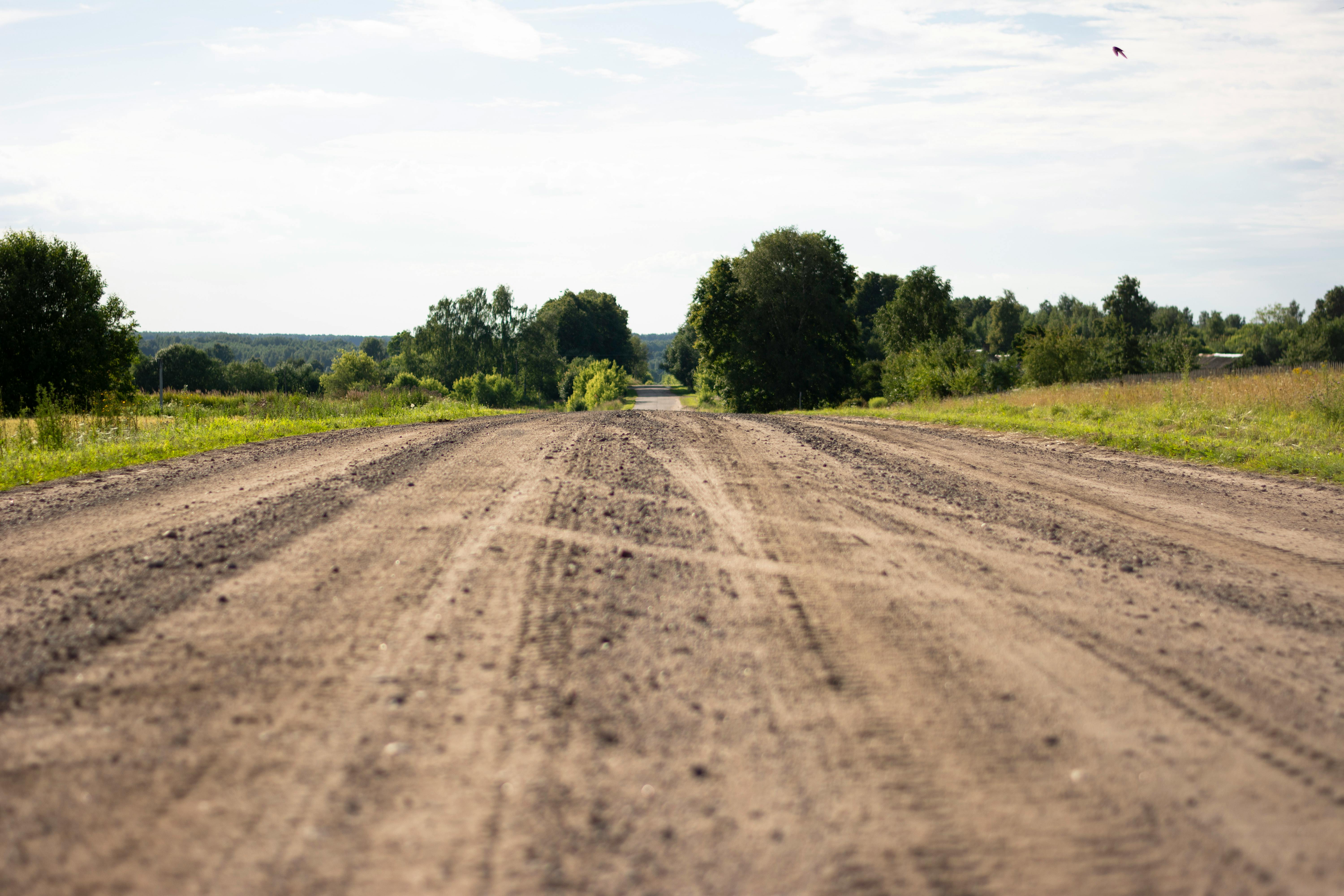 Photo of a Landscape with a Dirt Road · Free Stock Photo