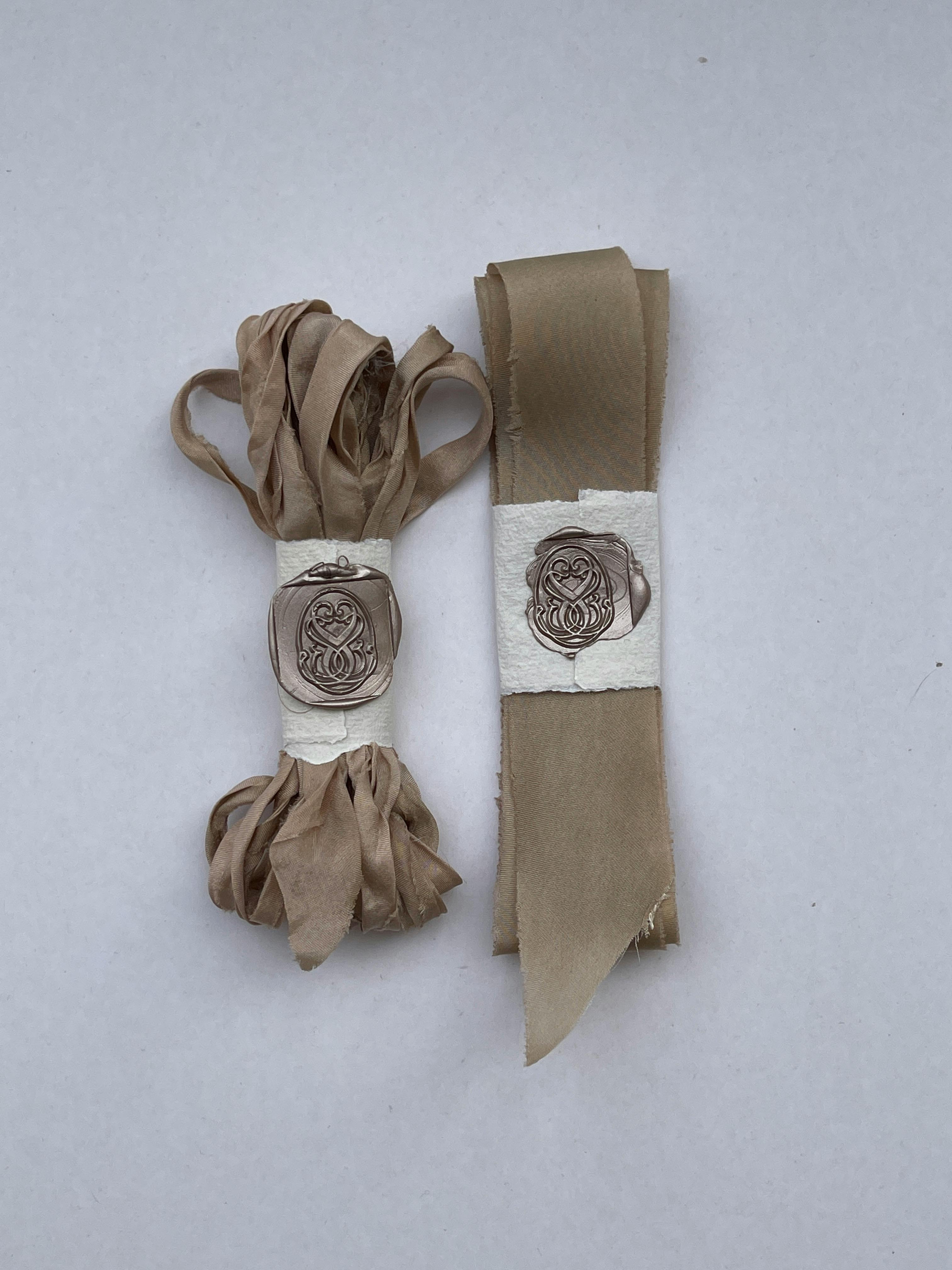 Photo of two Beige Ribbons on Grey Background · Free Stock Photo