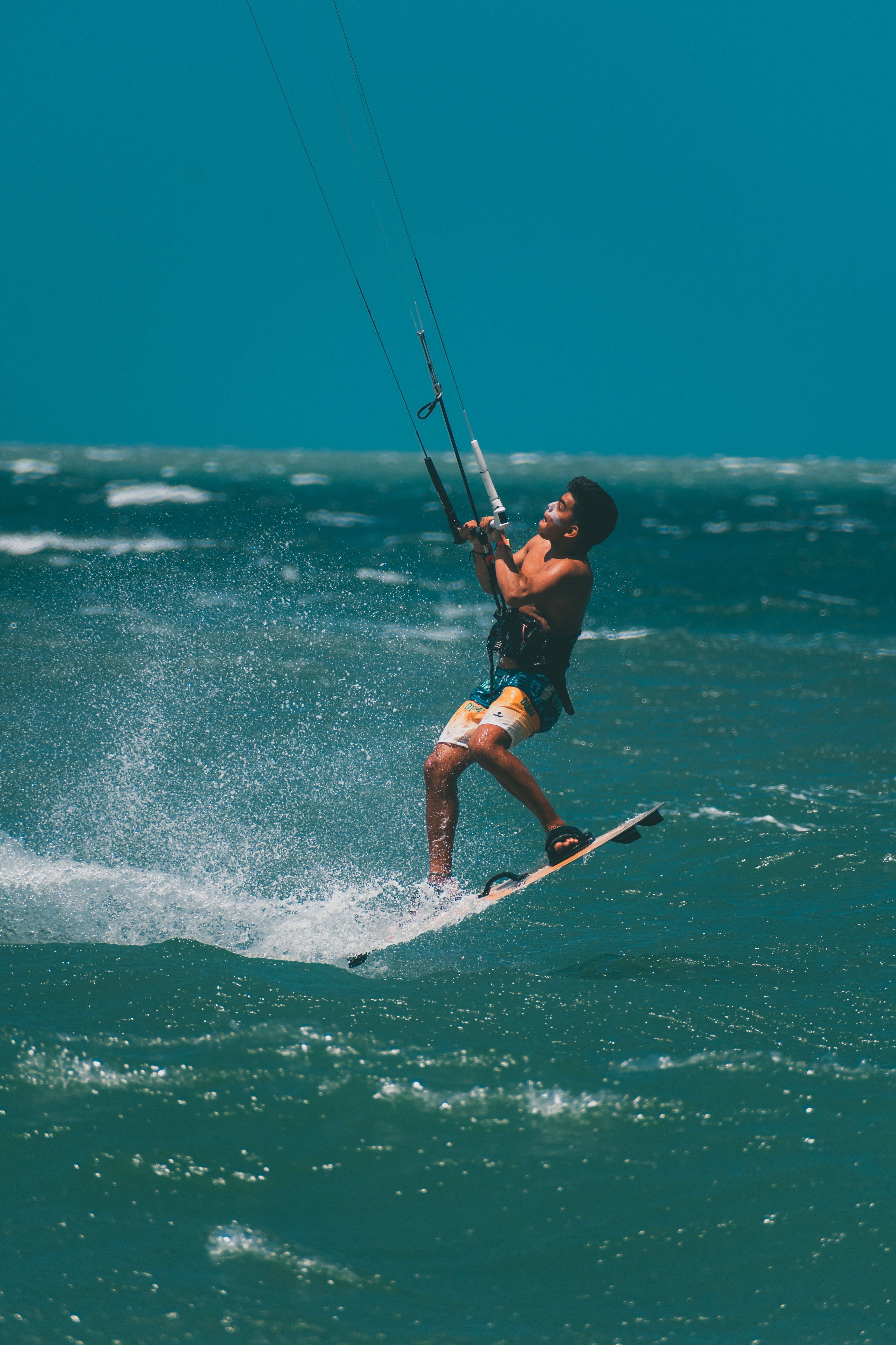 Man Holding a Wakeboard Running on the Beach · Free Stock Photo